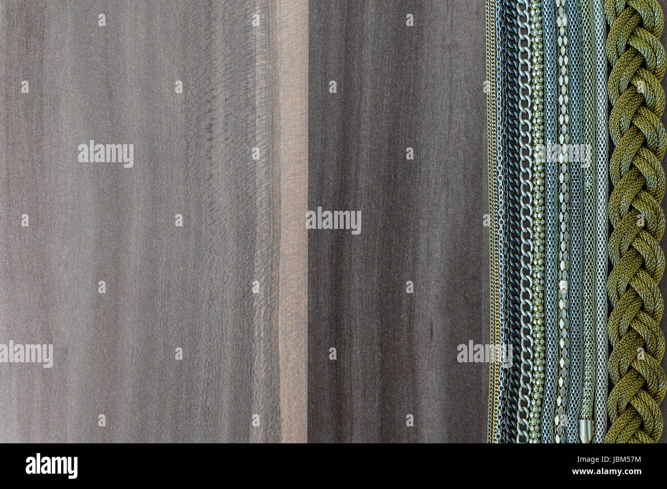 Rows of different chains on wooden background Stock Photo - Alamy