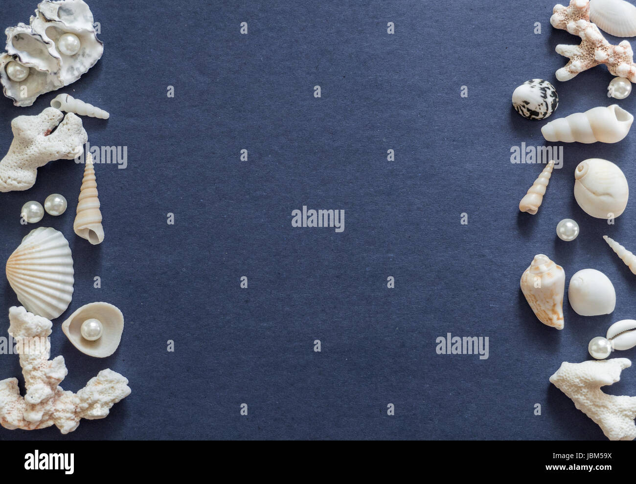 Blue background bordered by different shells and pearls on left and ...