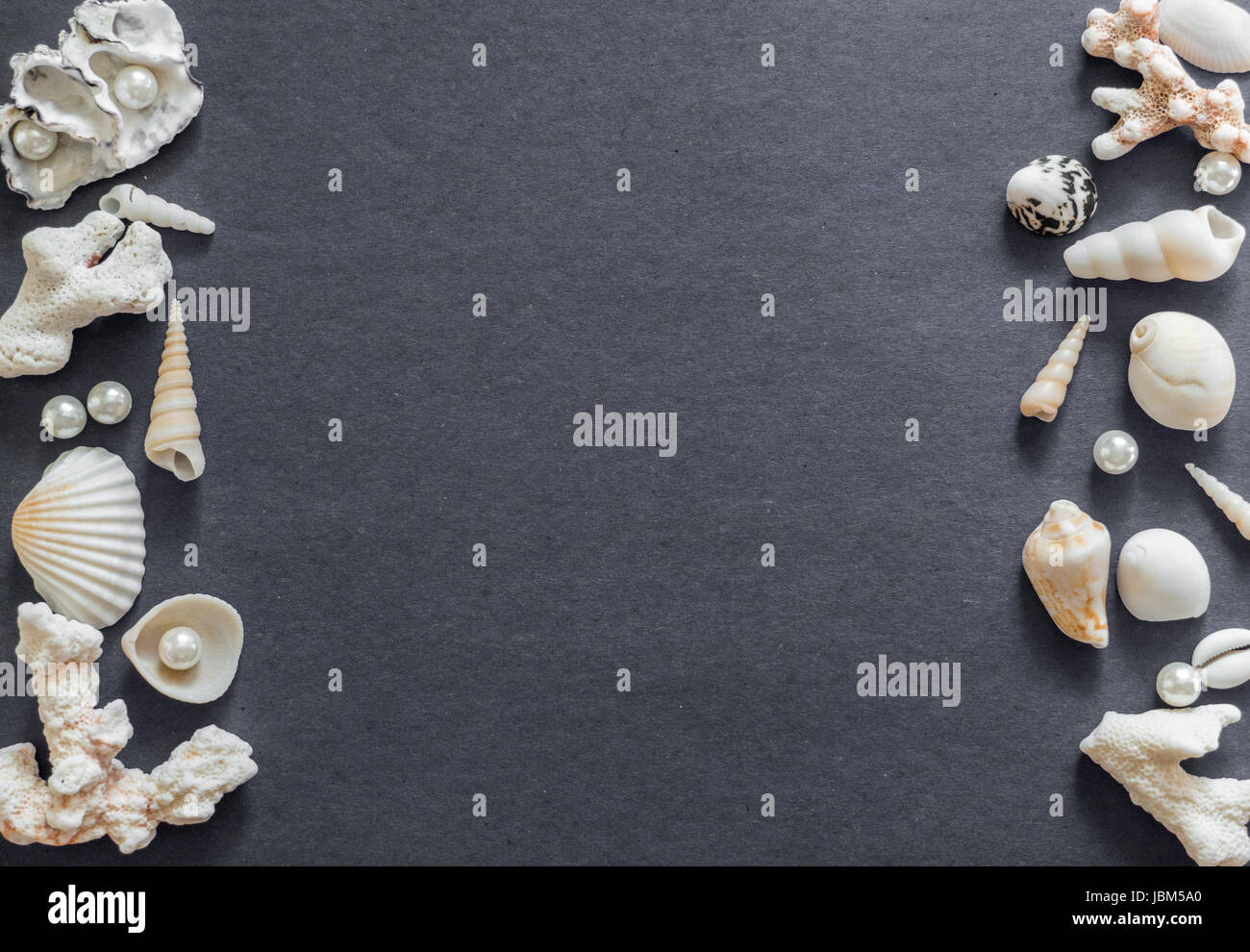 Desaturated blue background bordered by different shells and pearls on ...