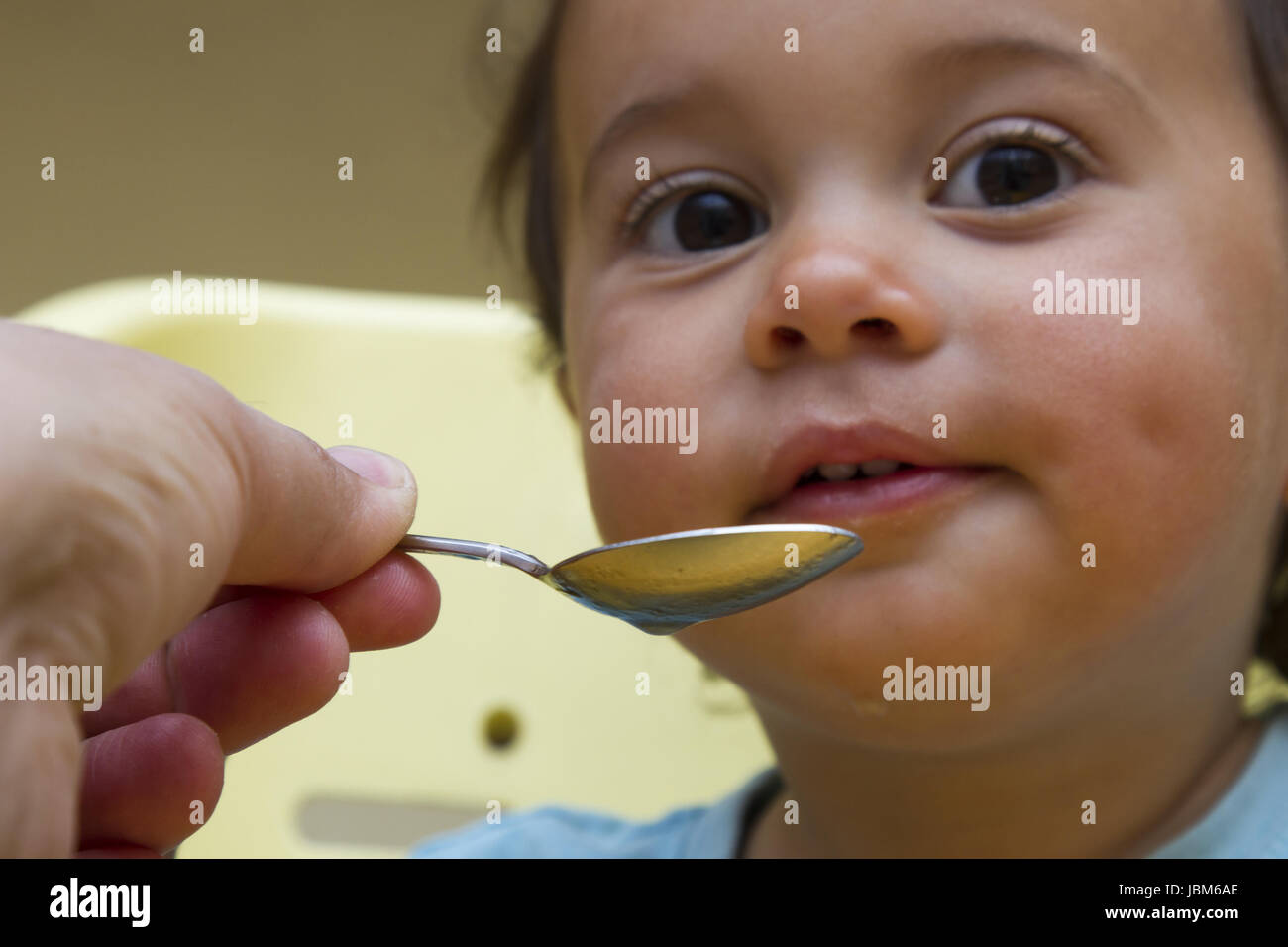 baby eating food on kitchen Stock Photo - Alamy