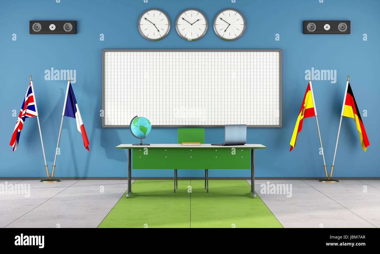 Classroom of a language school with teacher's desk and flags ...