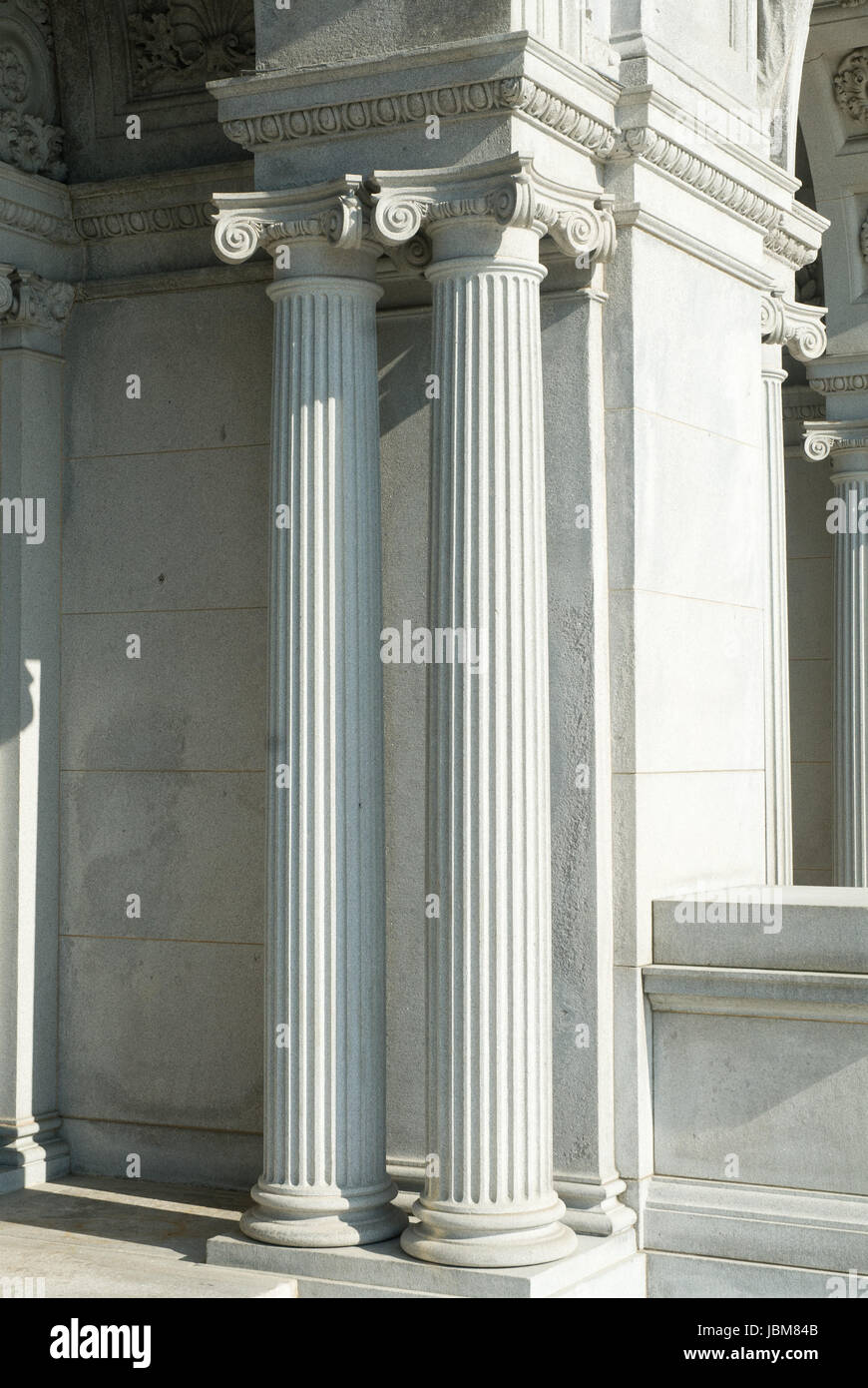 Pair of fluted classical columns at entrance of monumental building ...