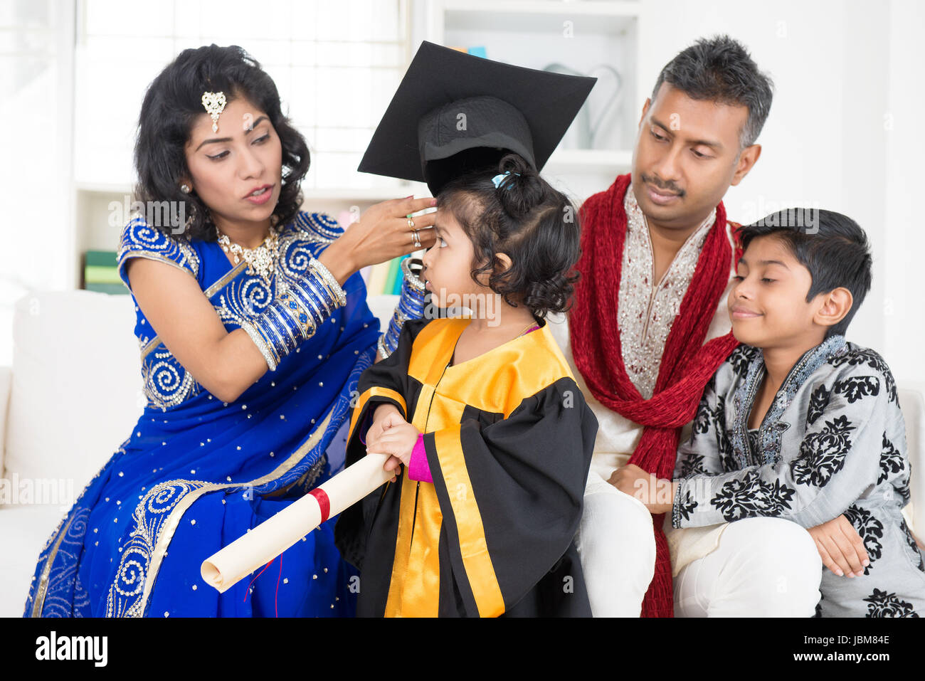 Kindergarten graduation. Asian Indian family, parents and children on ...
