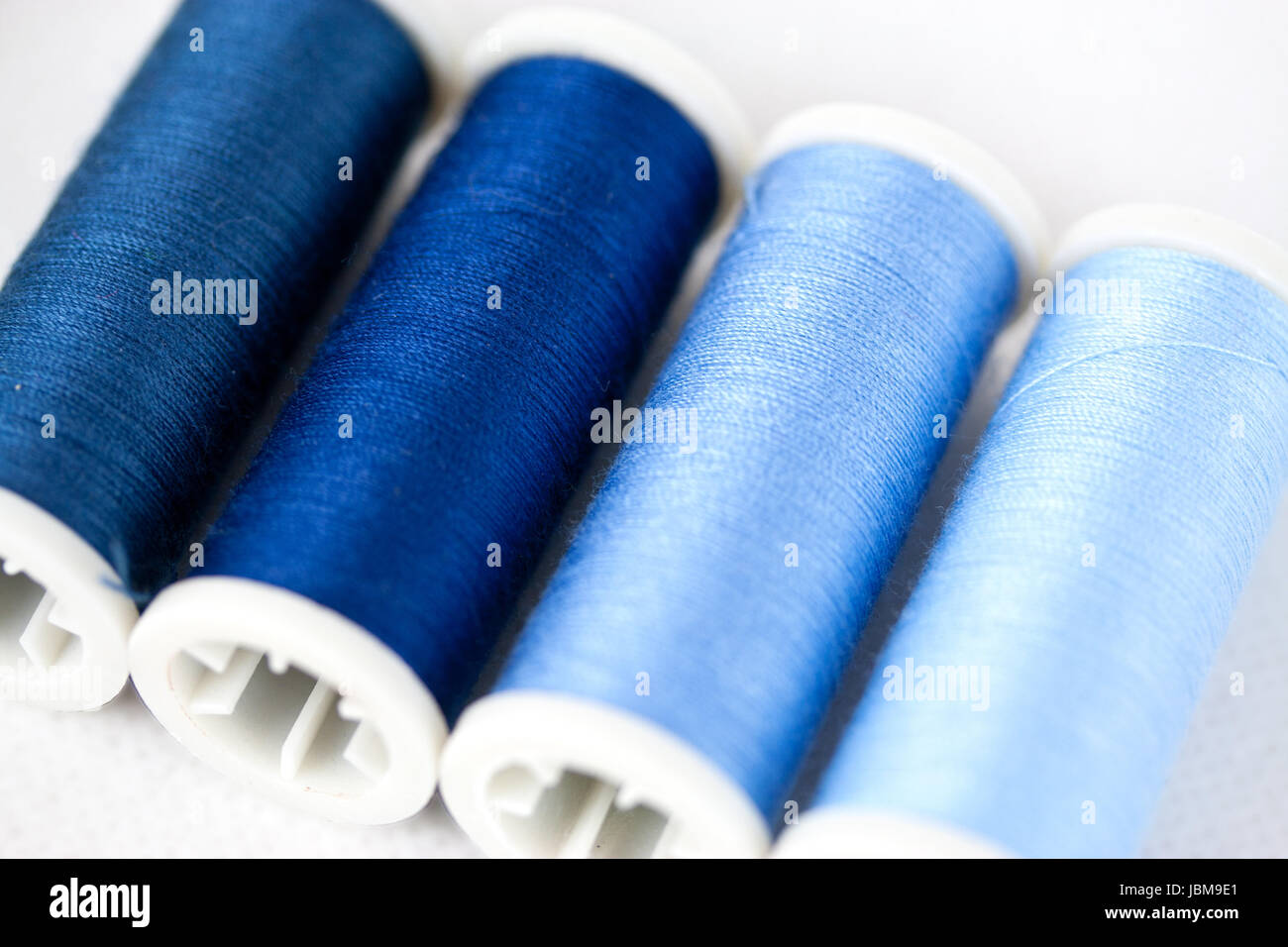 spools of thread blue Stock Photo - Alamy