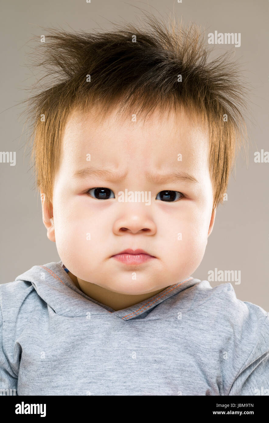 Serious baby boy Stock Photo - Alamy