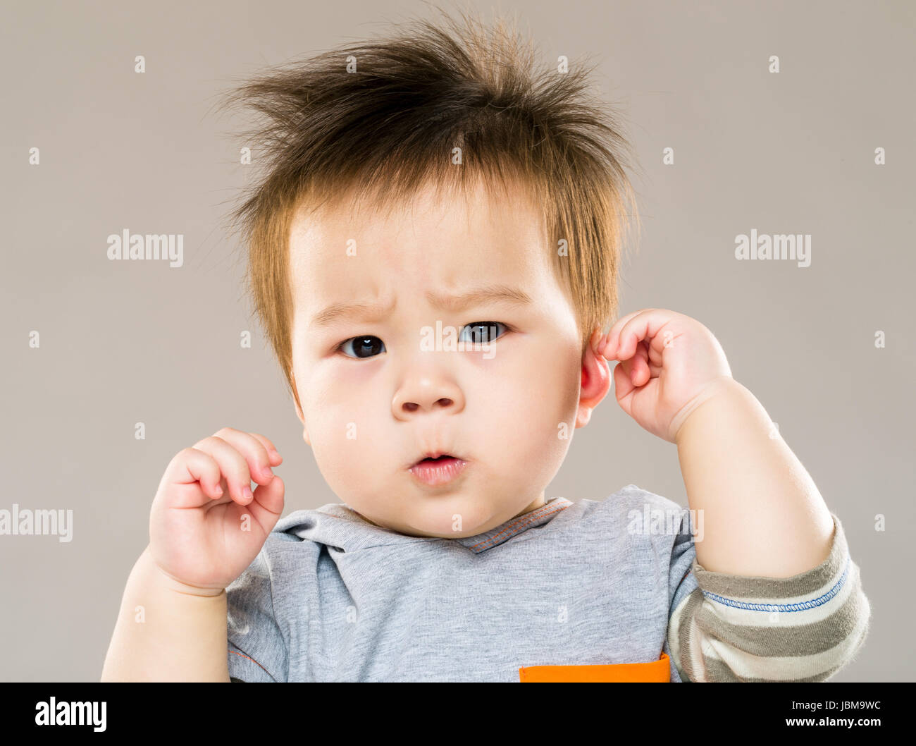 Adorable baby looking confused Stock Photo - Alamy