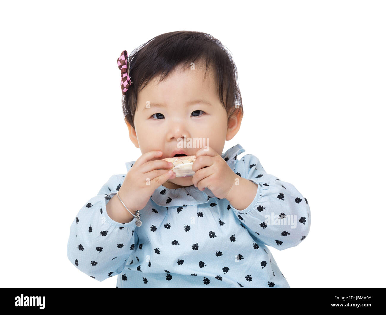 baby girl eating on white background Stock Photo - Alamy