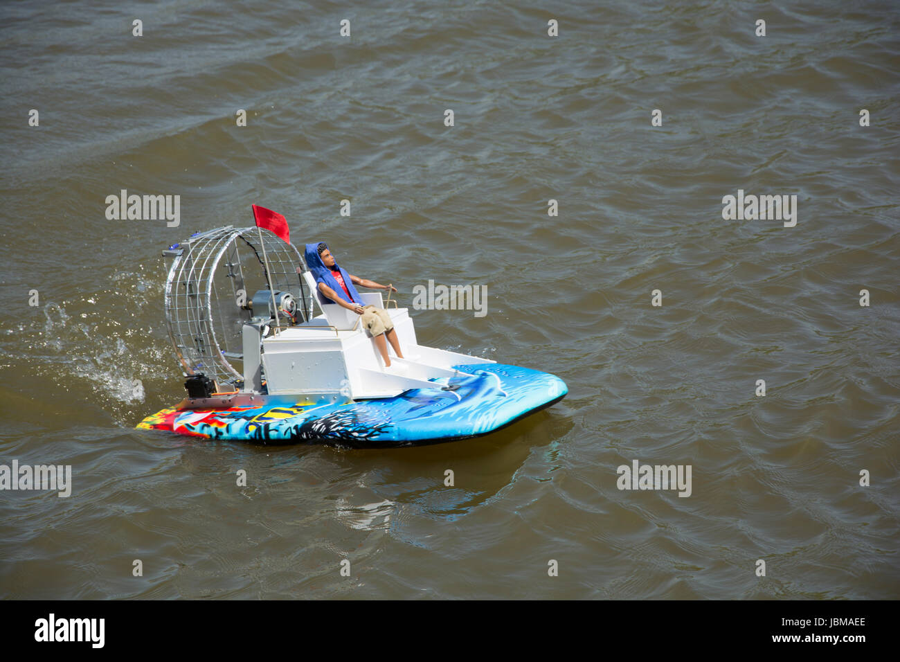 Handcrafted, radio controlled model hovercraft. They are swimming in ...