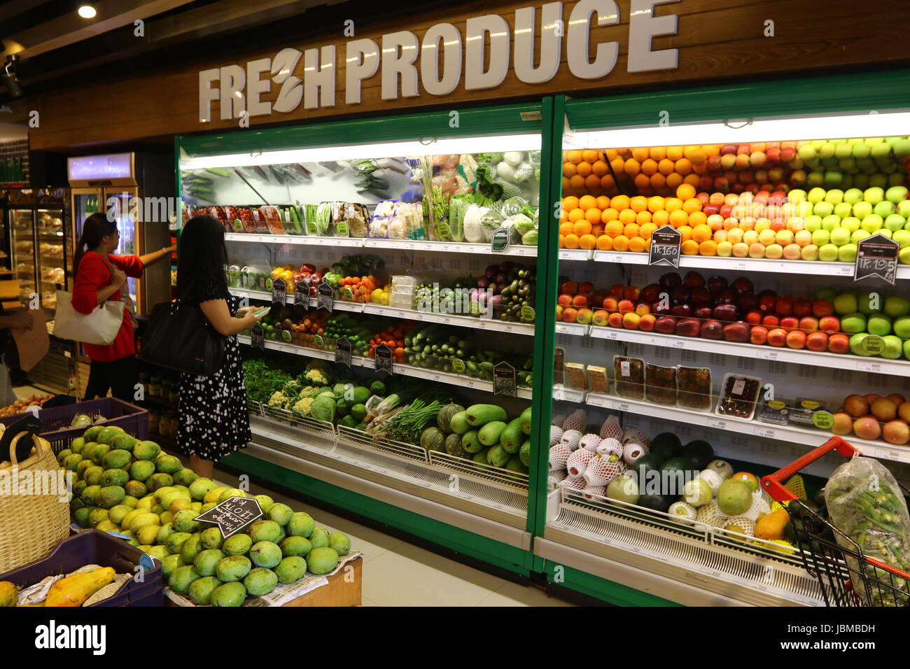 A customer buying organic vegetable and fruit in shopping mall Stock ...