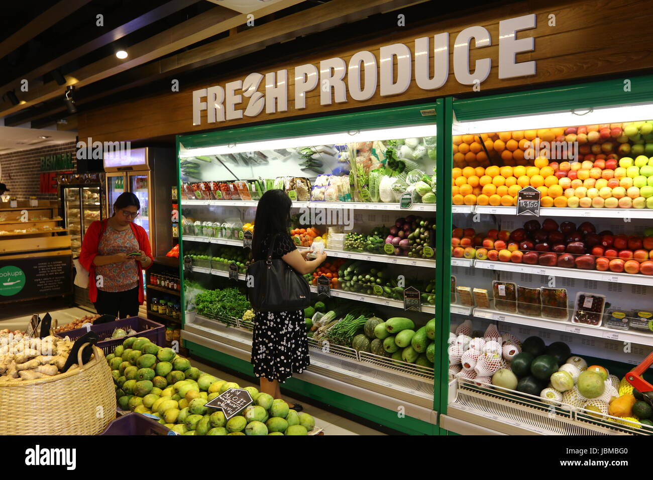 A customer buying organic vegetable and fruit in shopping mall Stock ...