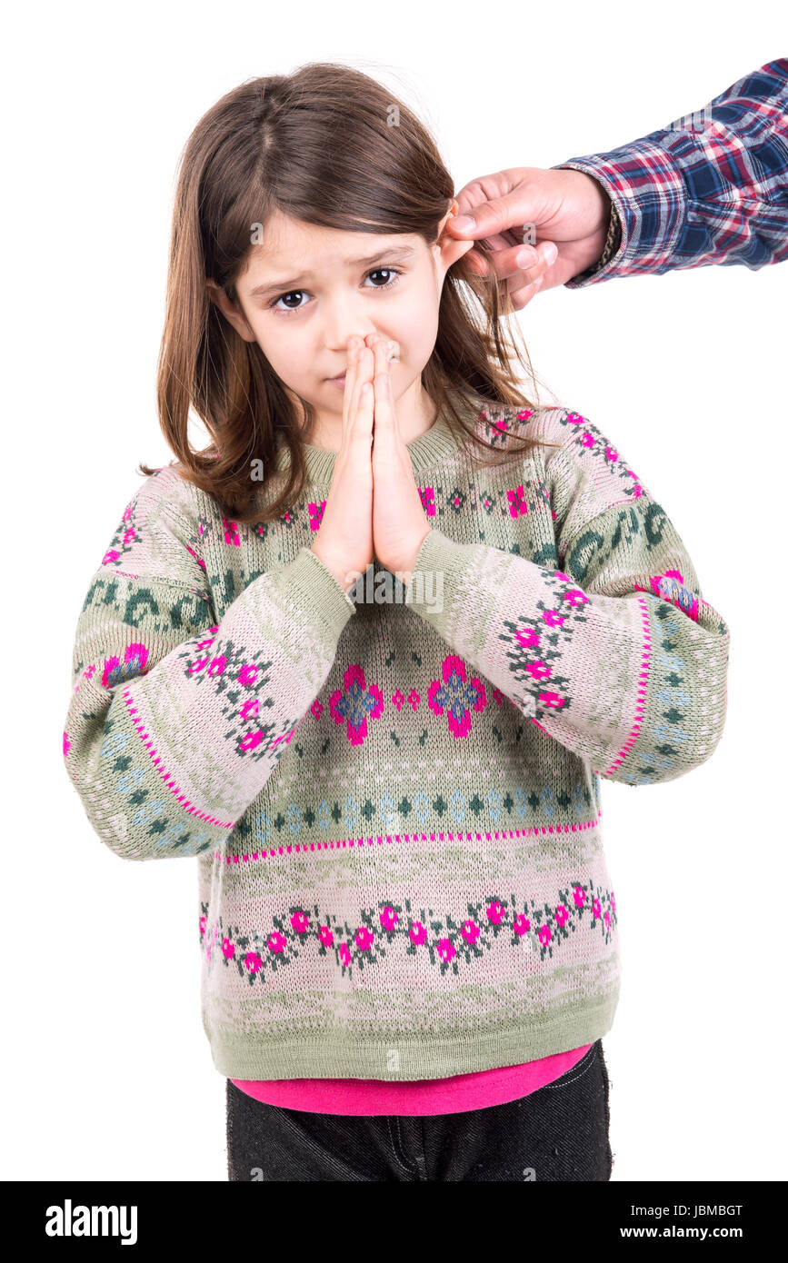 Young girl being punished with ear pulling Stock Photo - Alamy