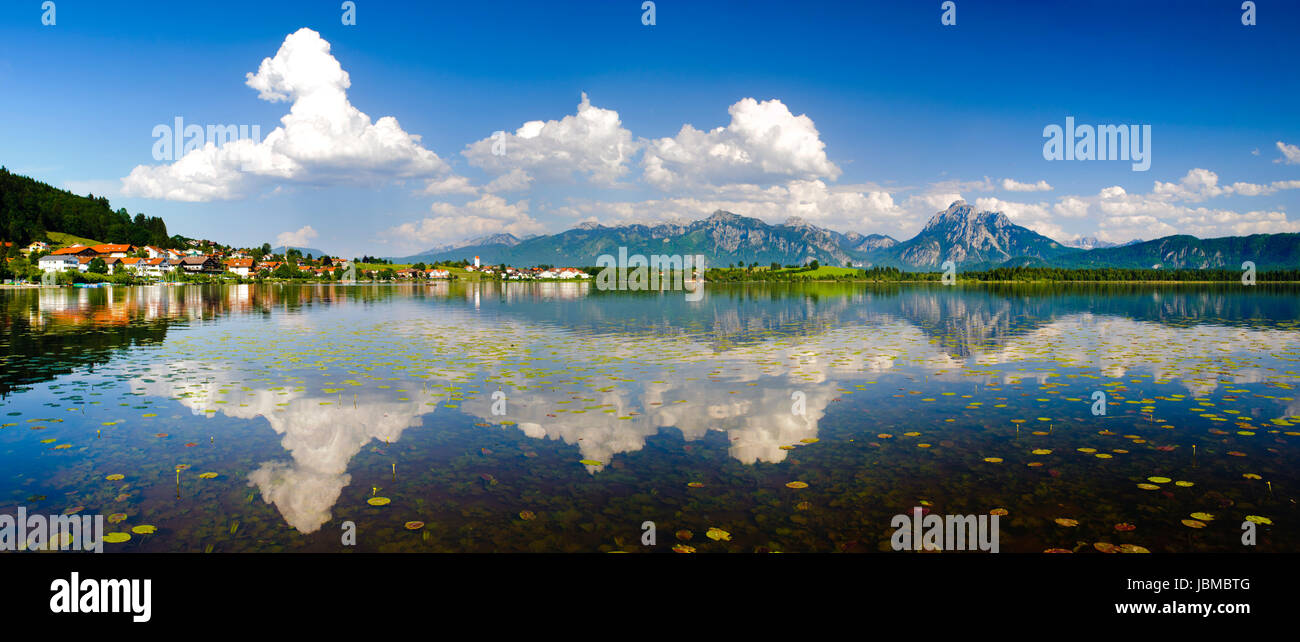 panorama landscape in Bavaria at lake Hopfensee with alps mountains ...