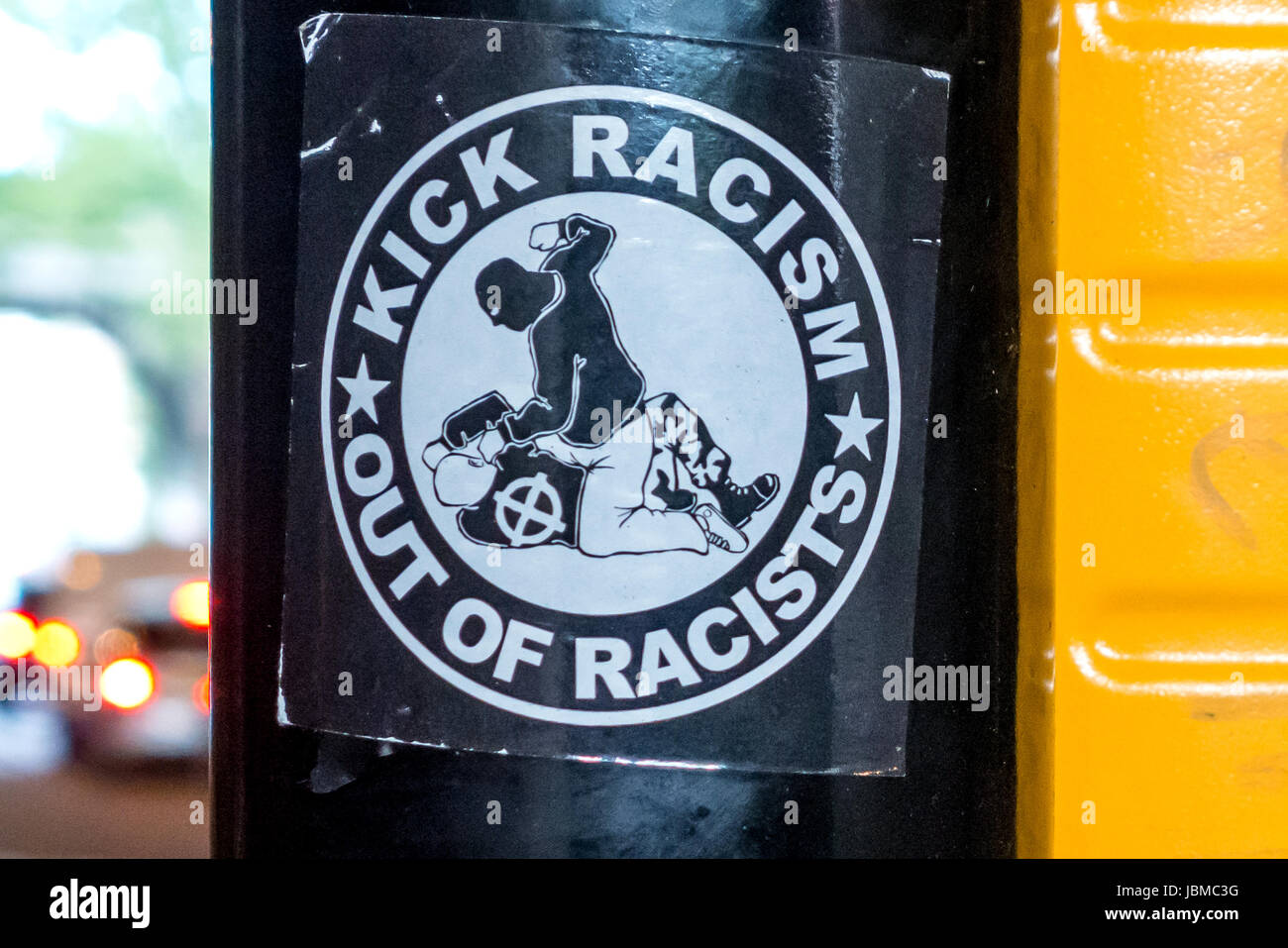 Street sticker advocating violence towards racists Stock Photo - Alamy