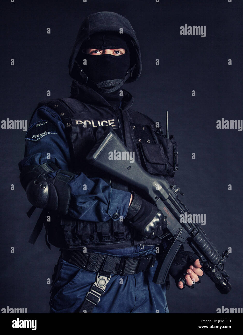 Special weapons and tactics SWAT team officer on black background Stock ...