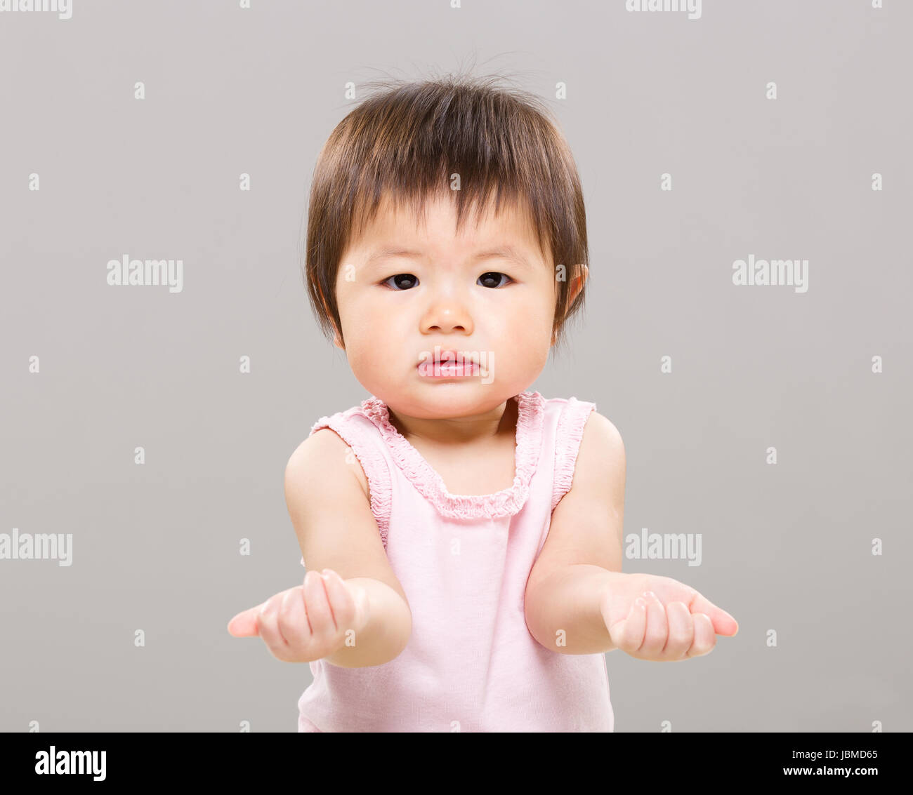 Baby girl with hand gesture showing nothing Stock Photo - Alamy