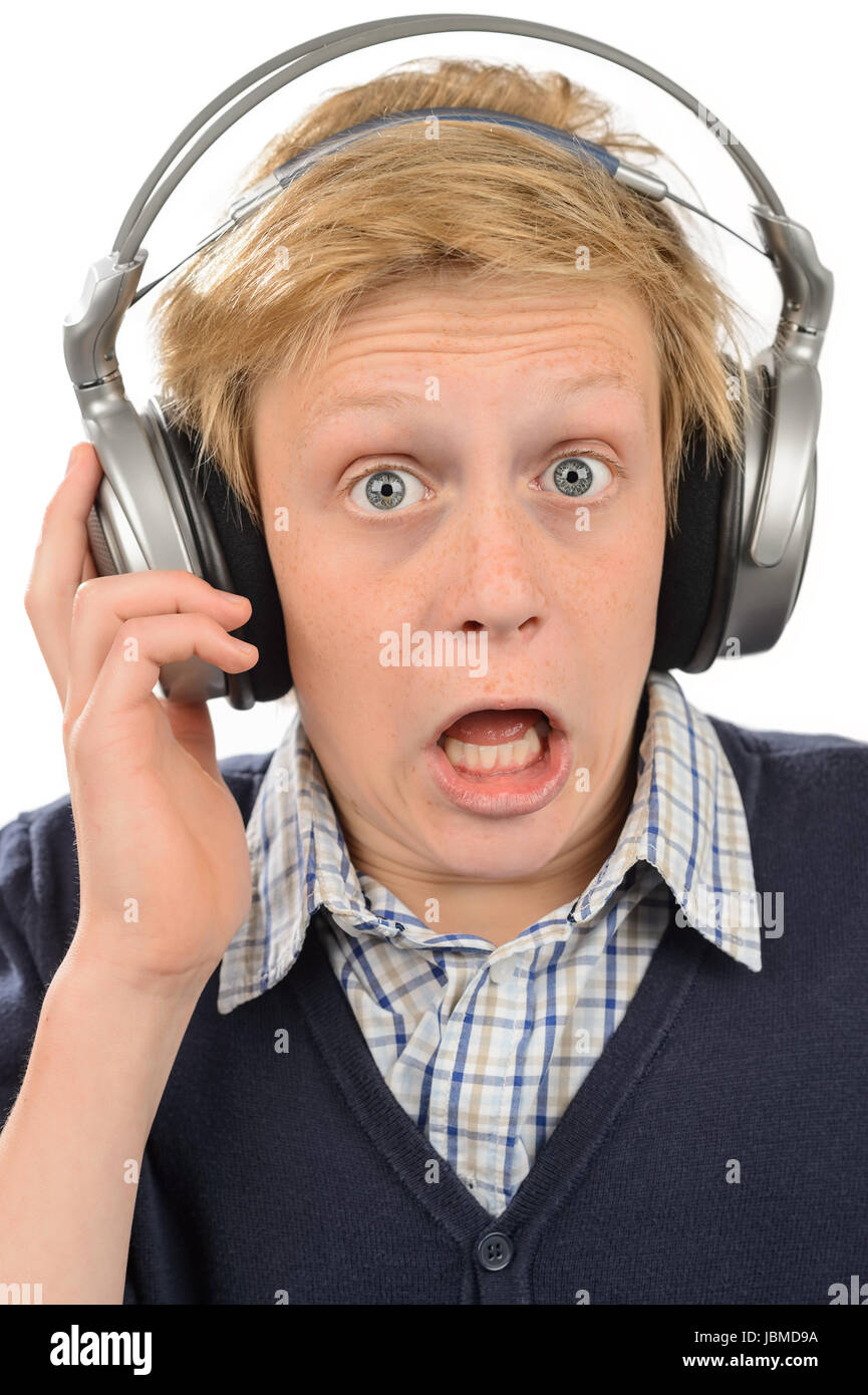 Shocked teenage boy wear headphones listening to music isolated on ...