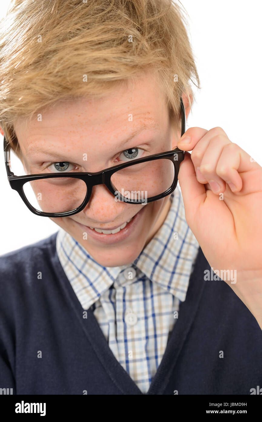 Cheerful nerd boy looking above geek glasses against white background ...
