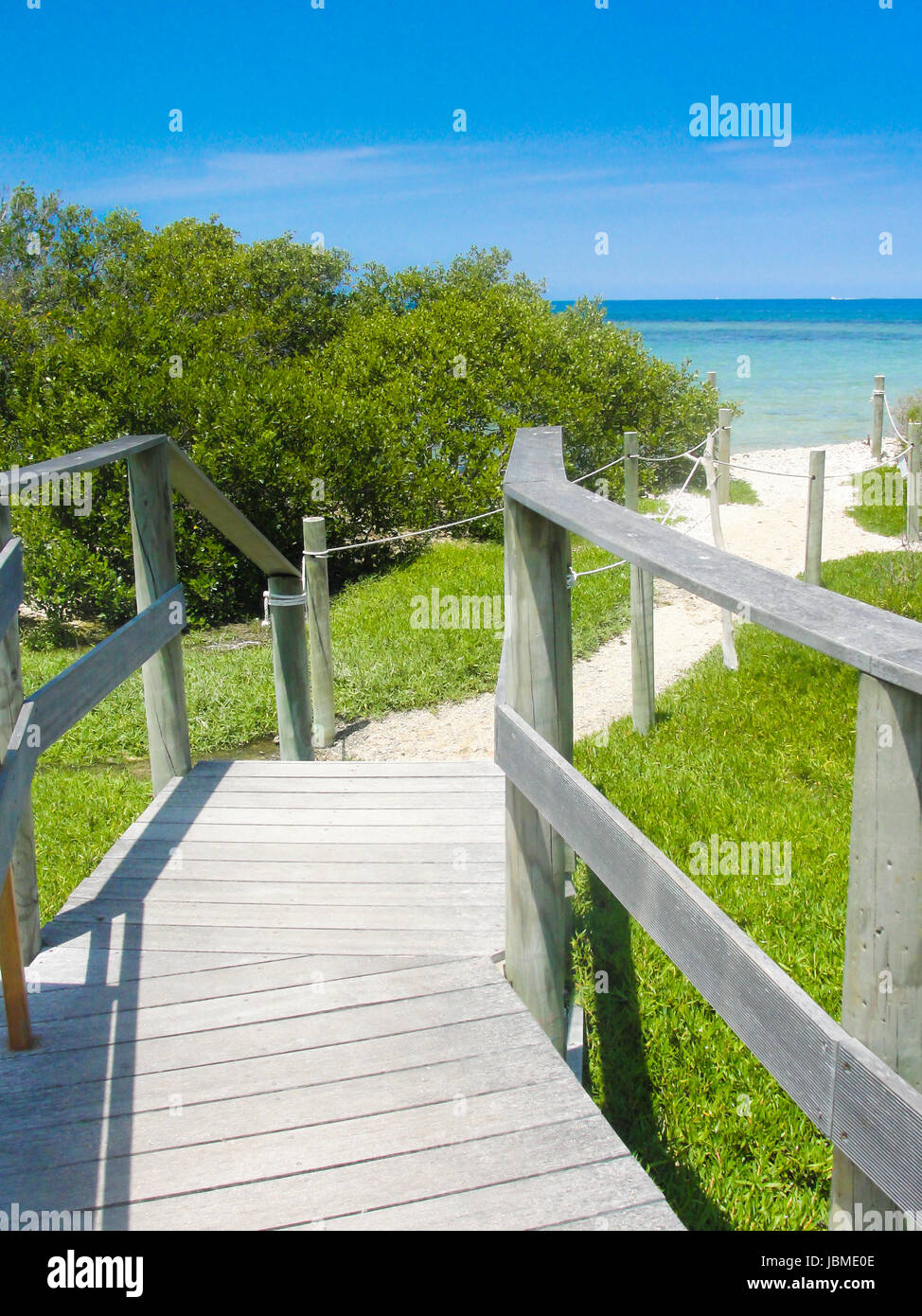 Wooden path to turquoise beach Stock Photo - Alamy