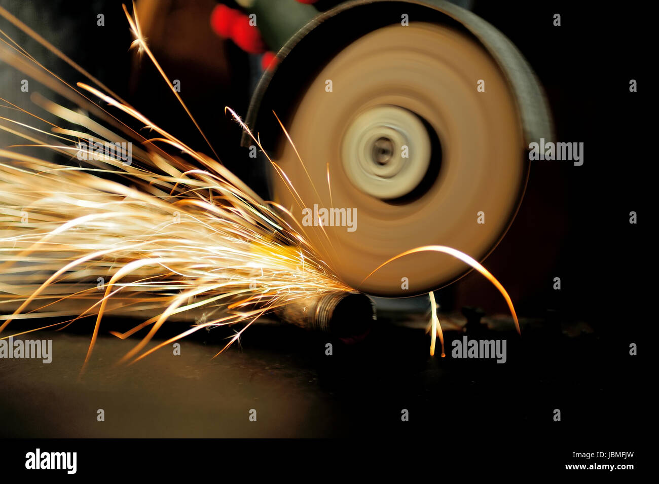 Worker cutting metal with grinder. Sparks while grinding iron Stock ...