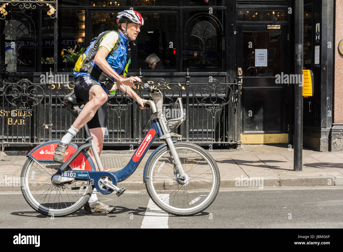 A man riding a Boris Bike on a London street Stock Photo - Alamy