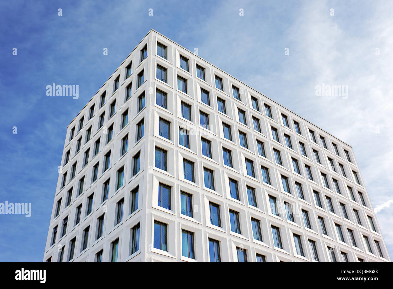 white multi-story building with light blue sky Stock Photo - Alamy