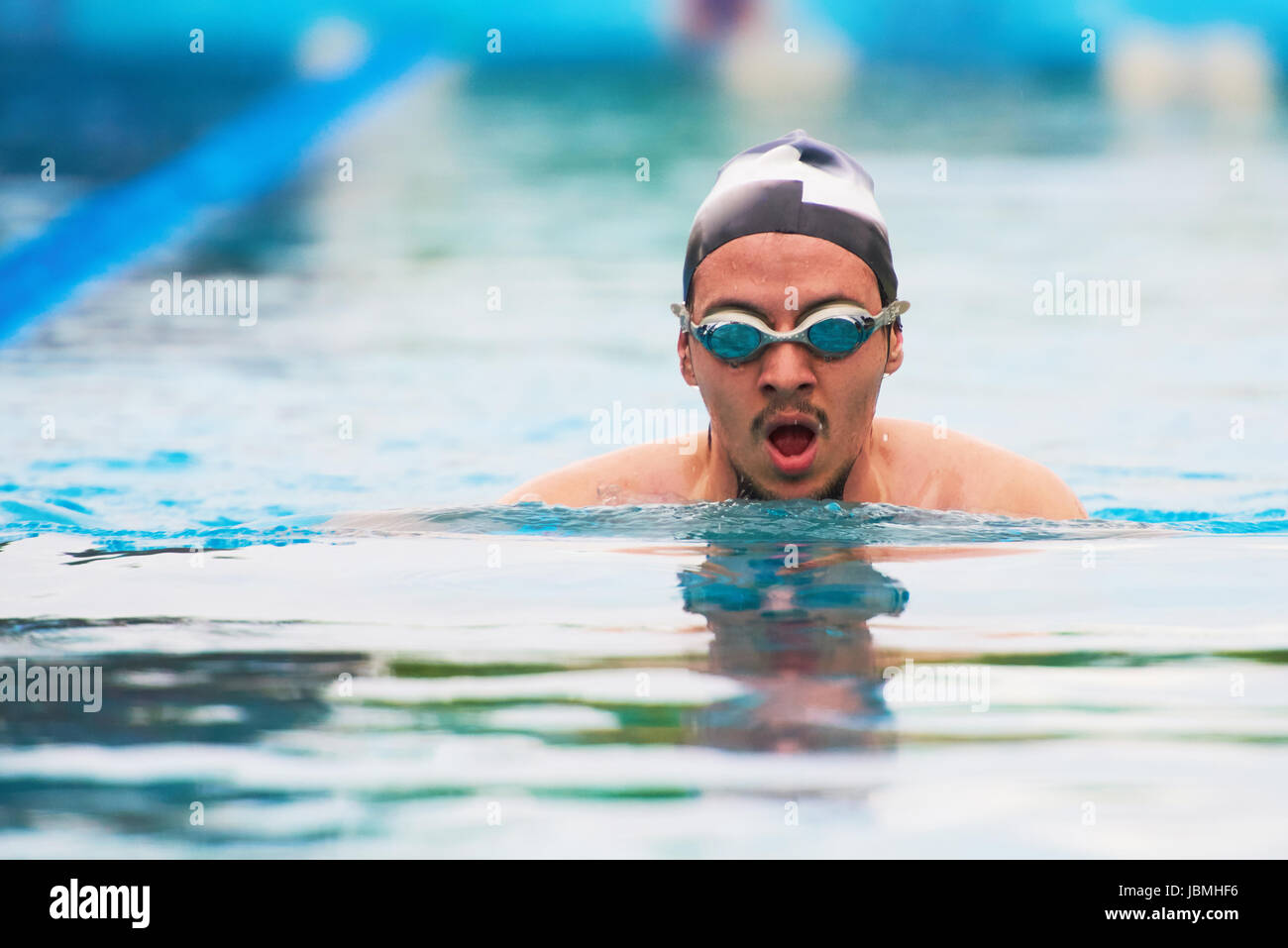 Man swimming in pool lane. Face of active hispanic man Stock Photo - Alamy