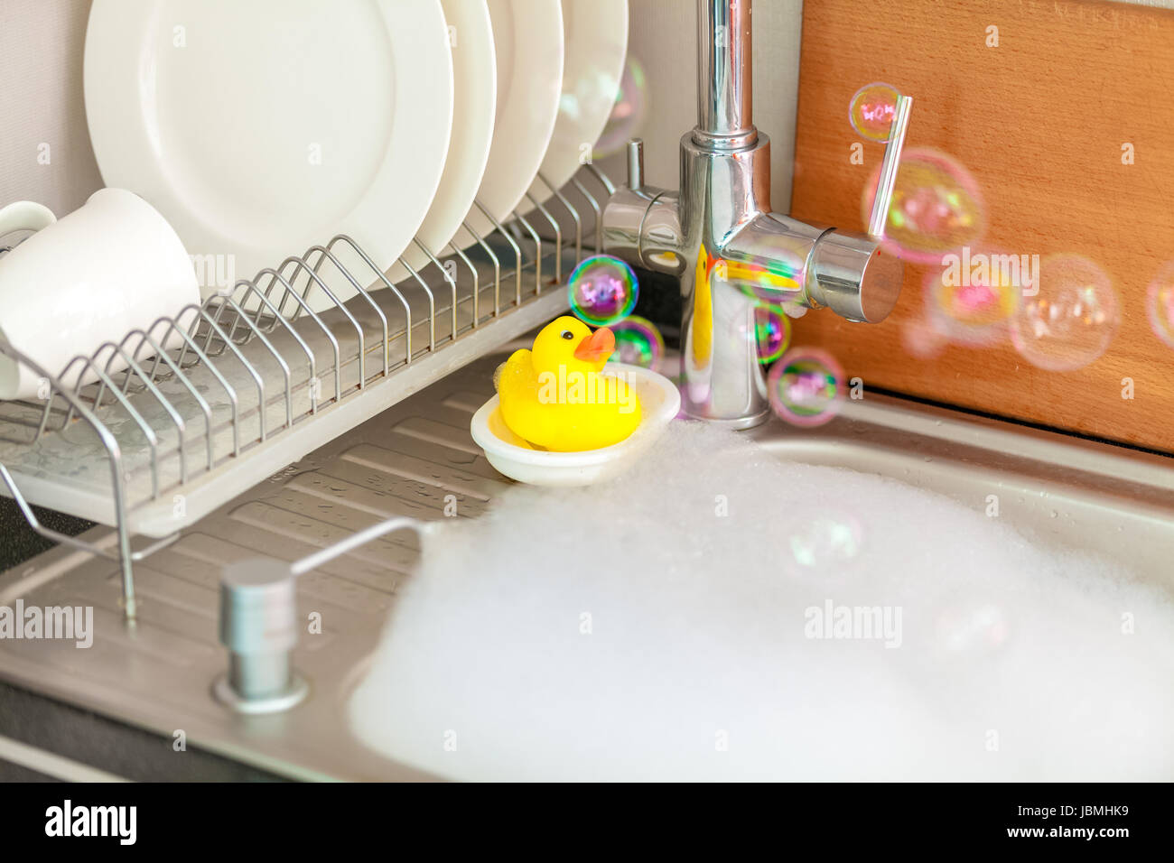 Closeup photo of yellow duck on kitchen sink in foam Stock Photo - Alamy
