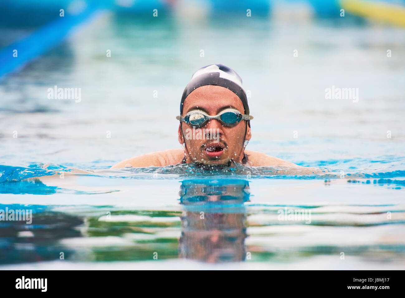 Swimming man in outside pool . Active exercise man close up portrait ...