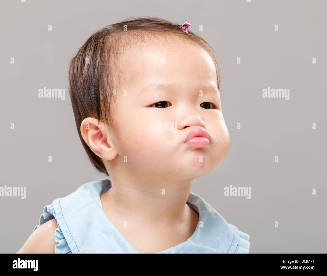 Baby making funny face Stock Photo - Alamy