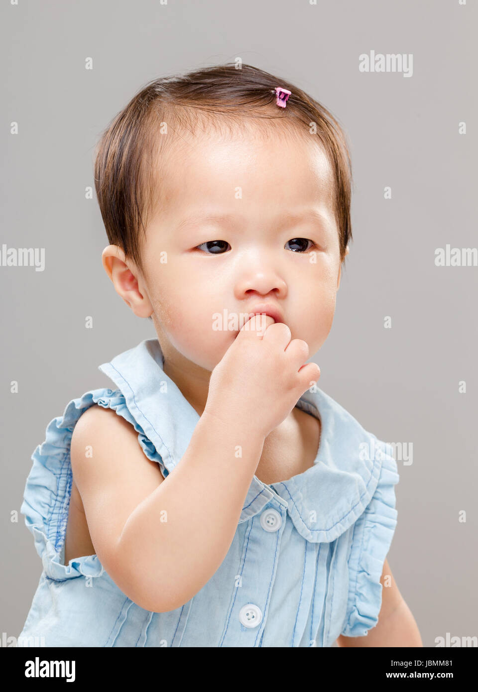 Little girl eating snack Stock Photo - Alamy