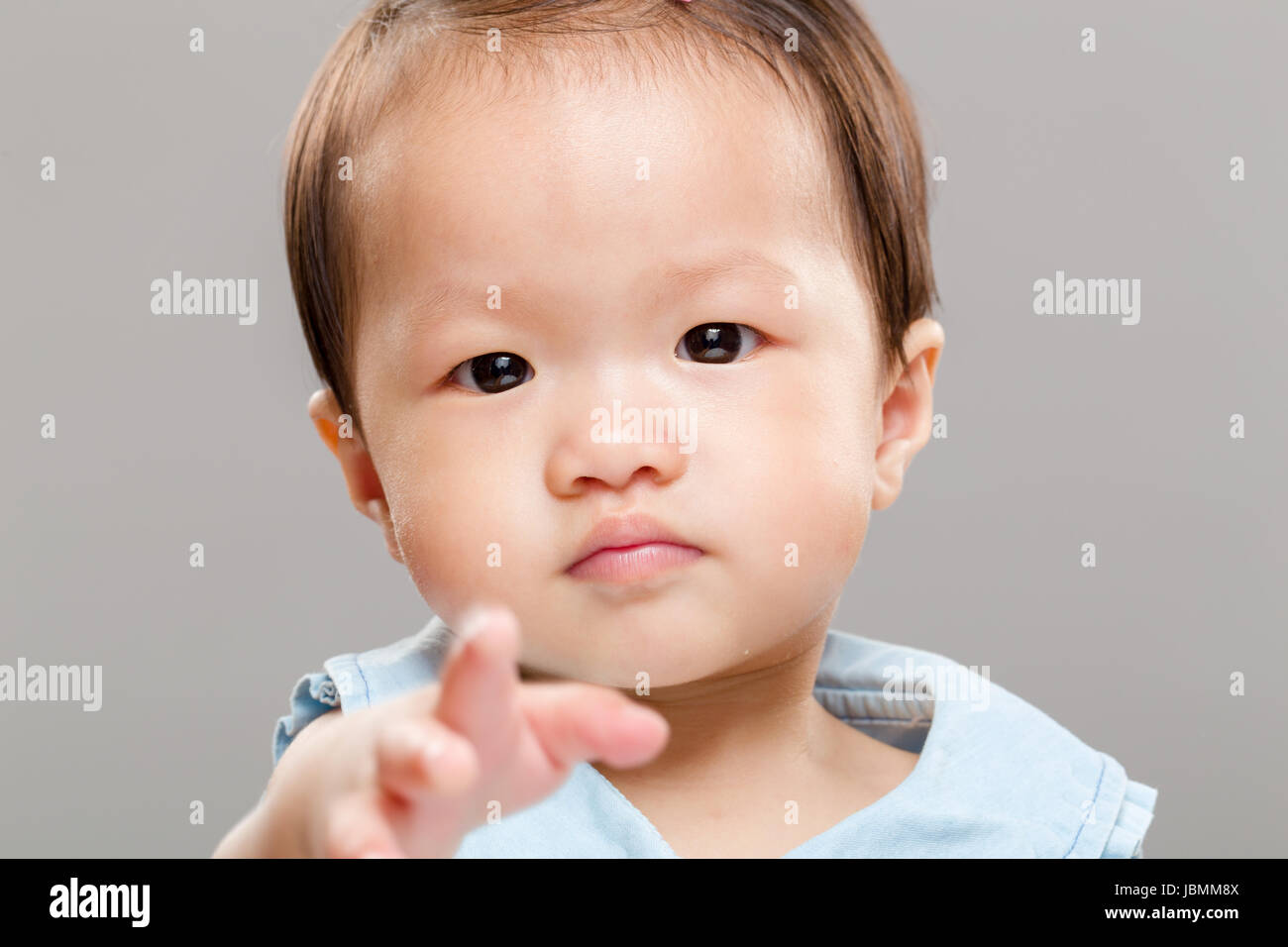 Funny baby girl pointing finger Stock Photo - Alamy