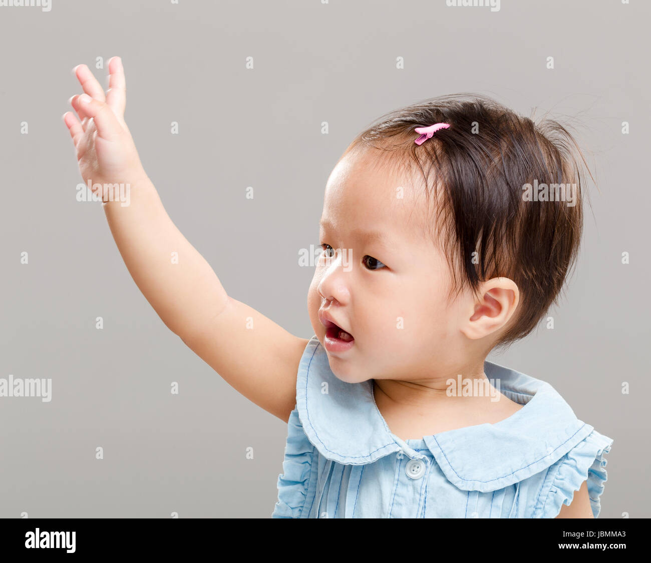 Little girl raise her hand up Stock Photo - Alamy