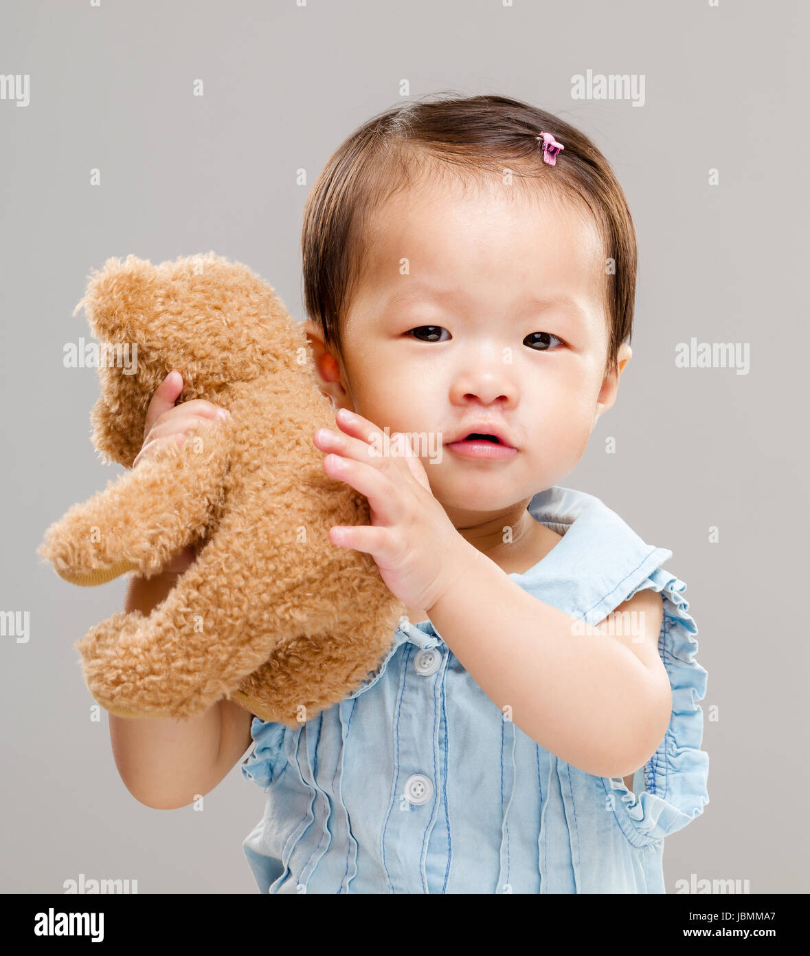 Sweet baby girl hug her toy doll Stock Photo - Alamy