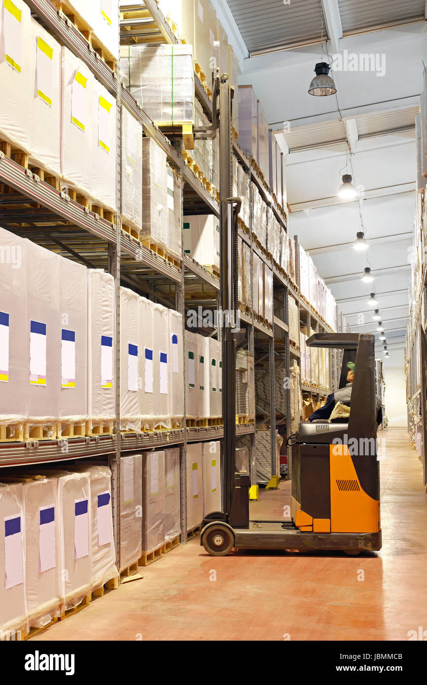 Loading goods with forklift in distribution warehouse Stock Photo - Alamy