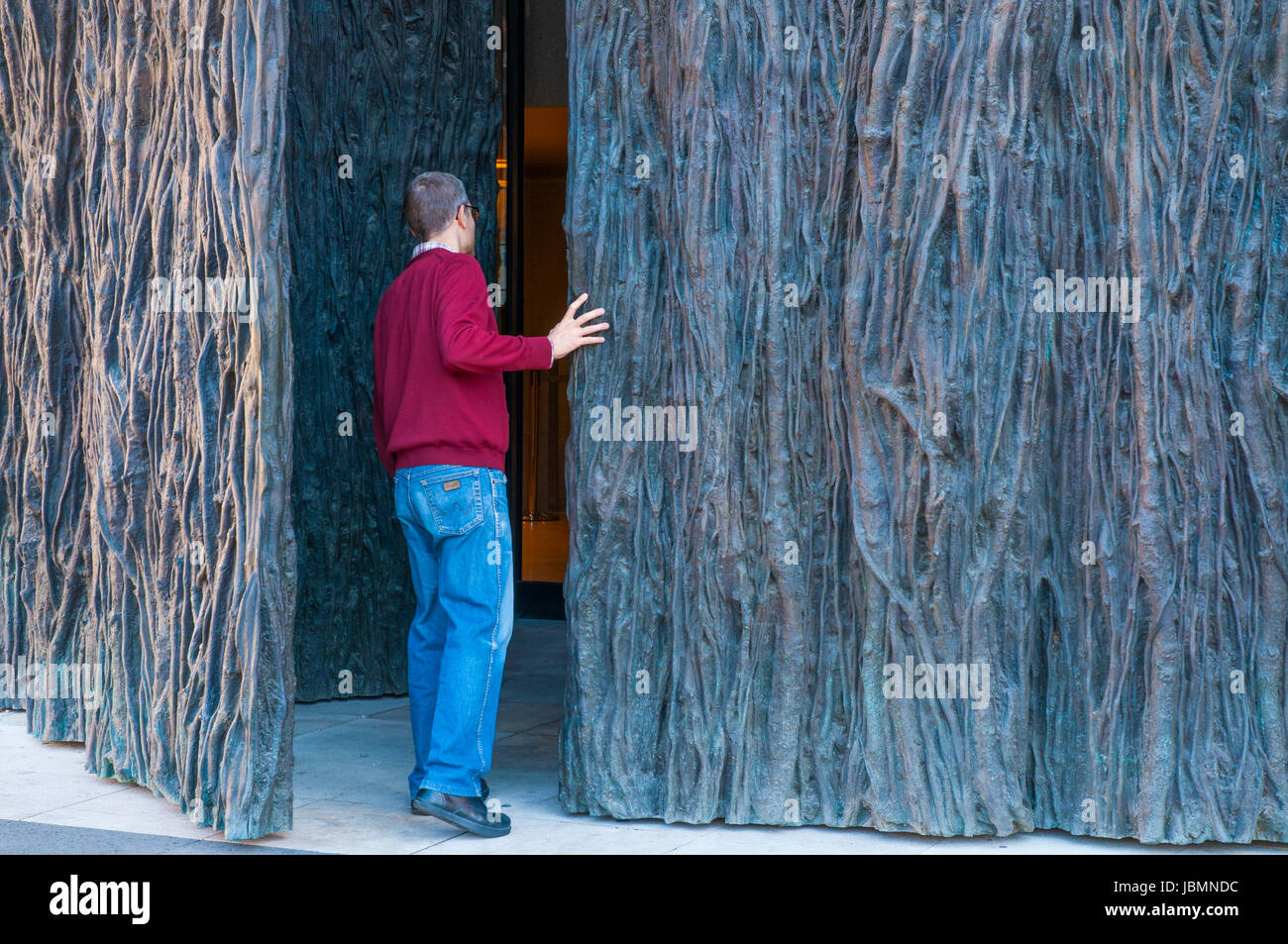 Man looking inside a place through an open door Stock Photo - Alamy