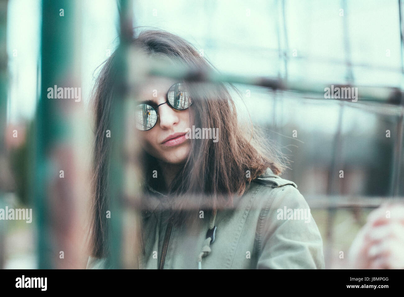 Woman at wire fence Stock Photo - Alamy