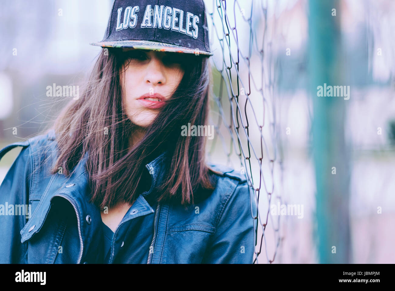 Woman at wire fence Stock Photo - Alamy