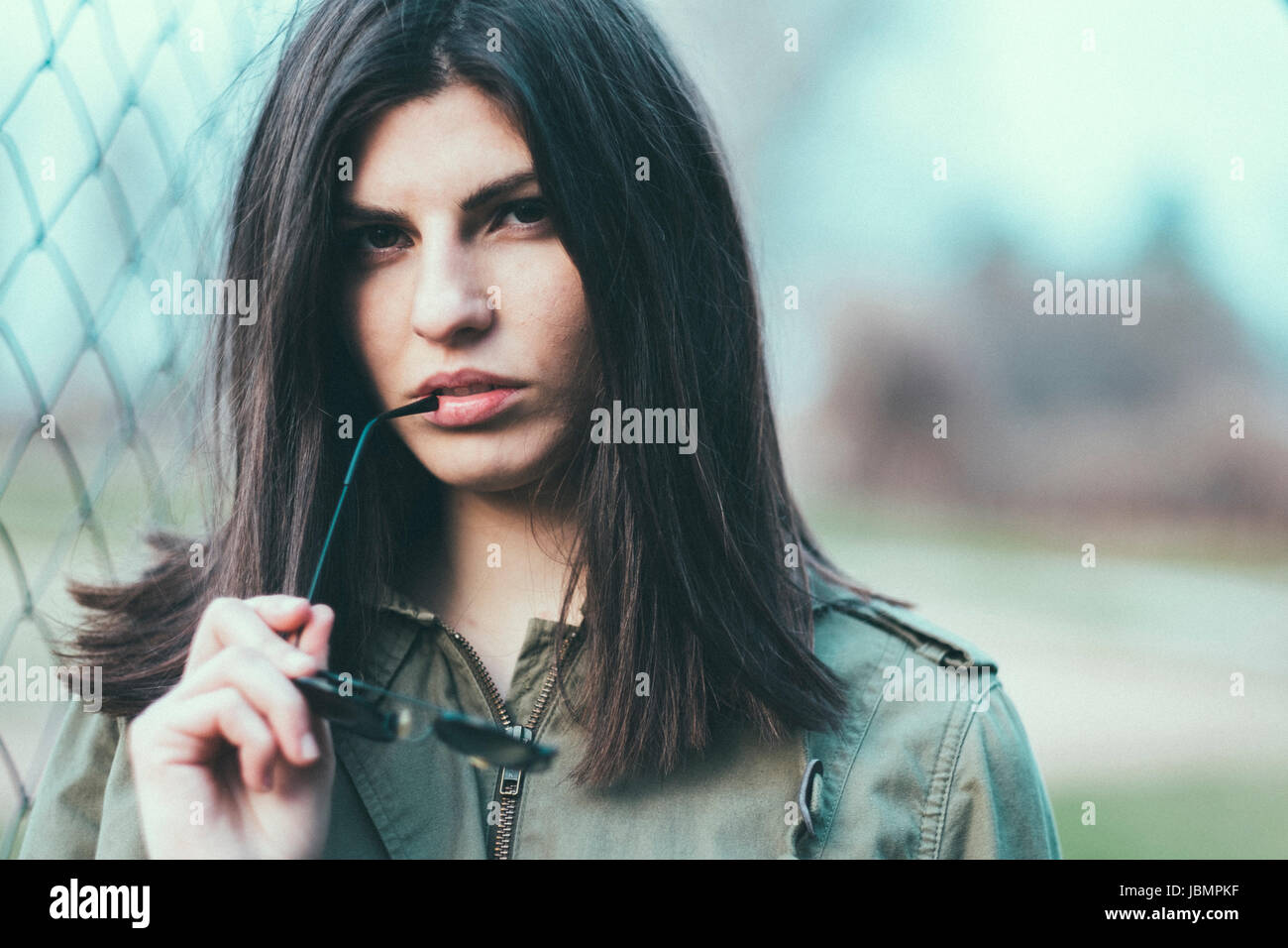 Woman at wire fence Stock Photo - Alamy