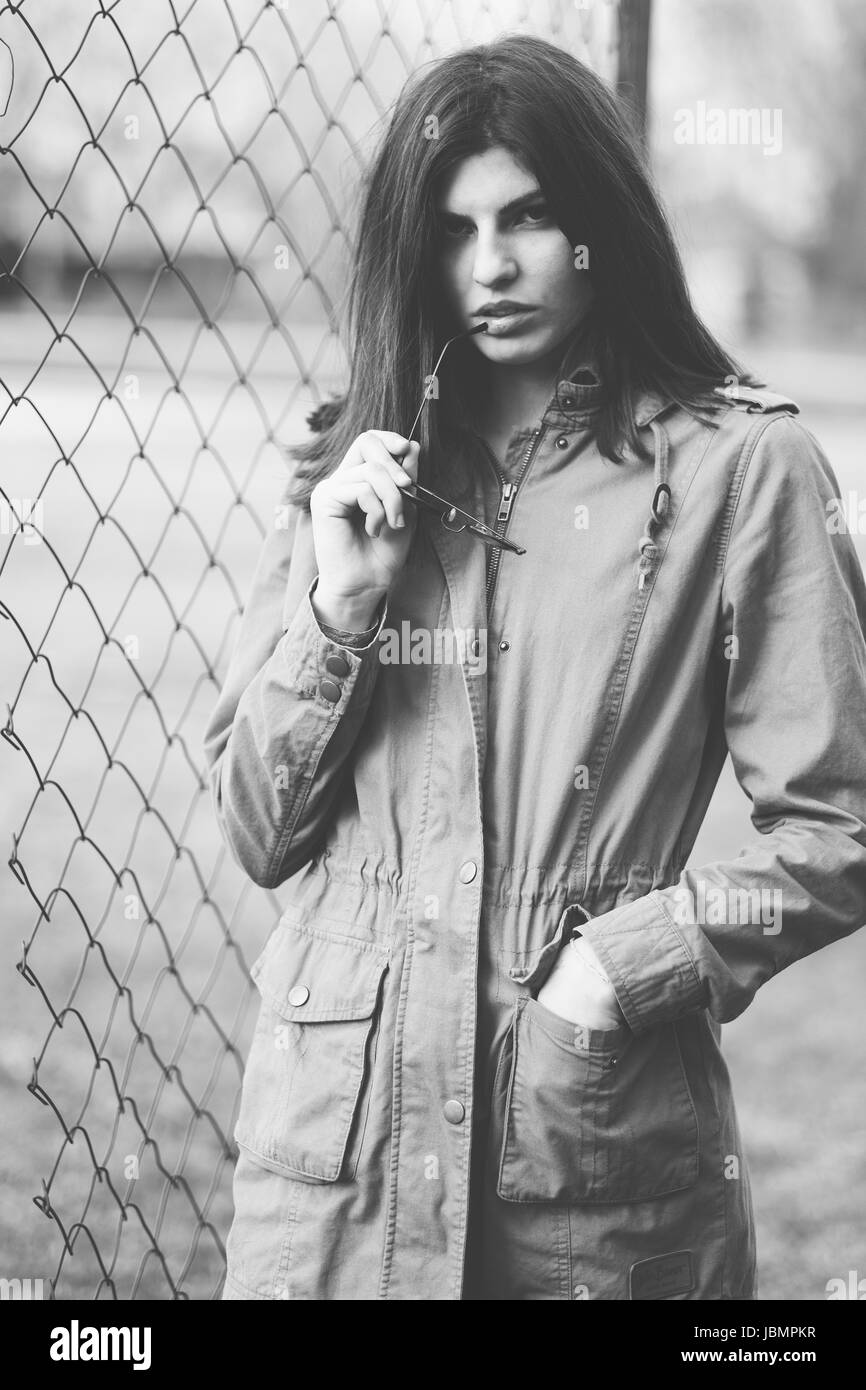 Woman at wire fence Stock Photo - Alamy