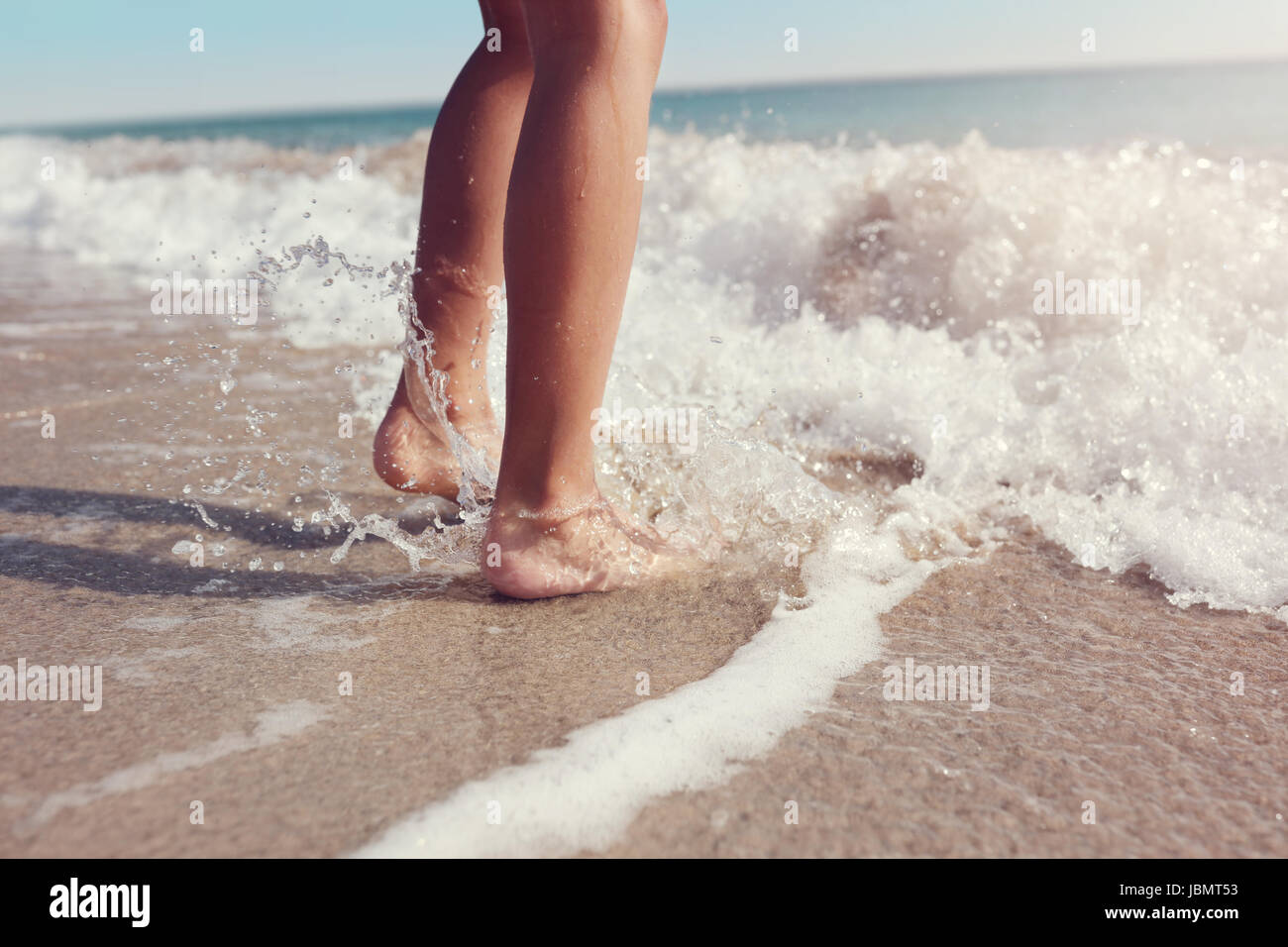 Child jumping over waves hi-res stock photography and images - Alamy