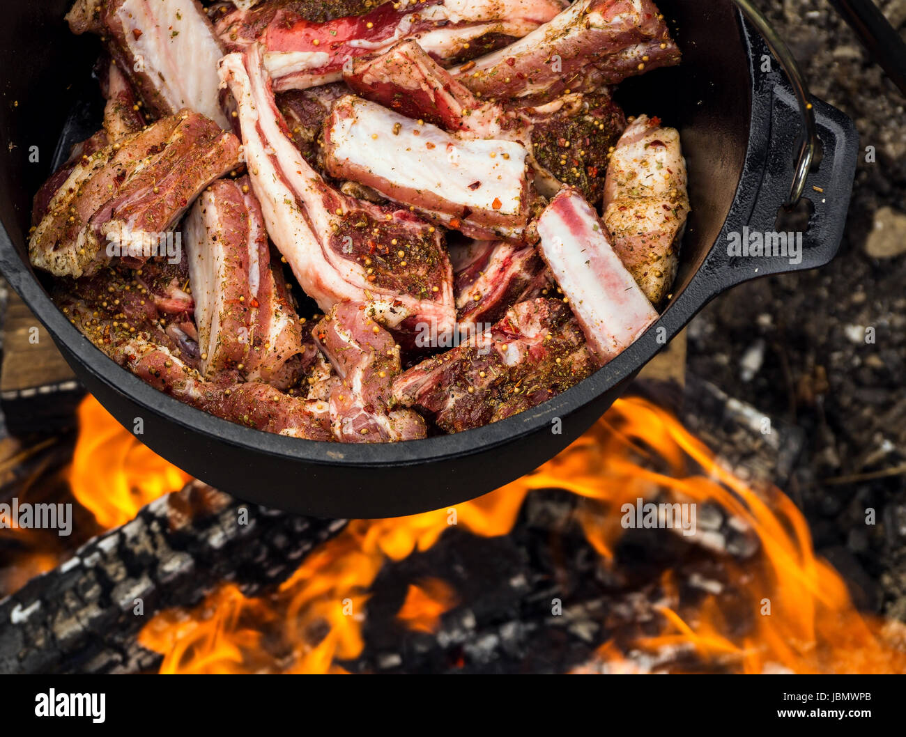 Cauldron full of lamb meat Stock Photo - Alamy