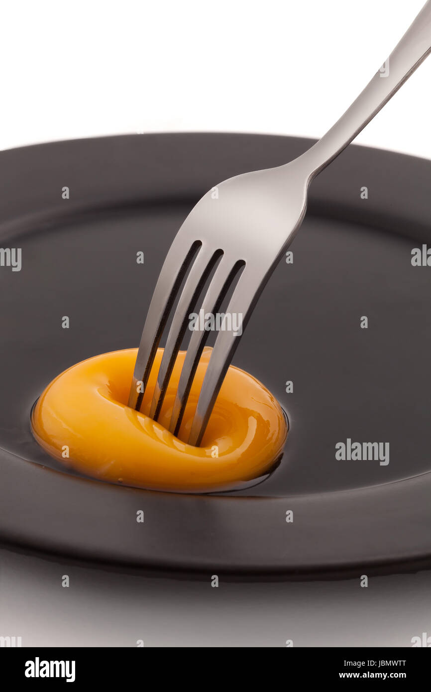 Egg yolk with fork pricking Stock Photo - Alamy