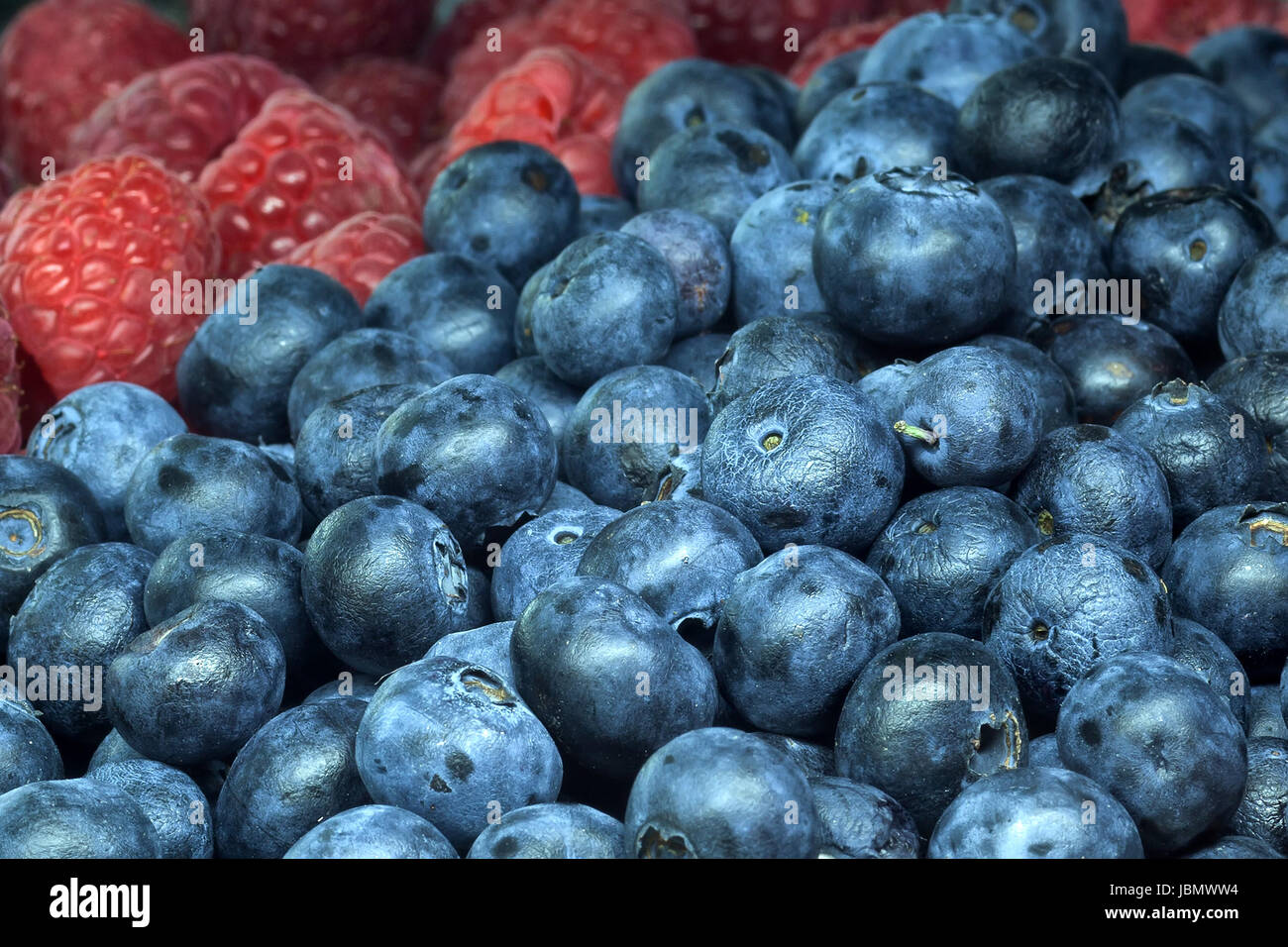 Blueberry and raspberry fruits background Stock Photo - Alamy