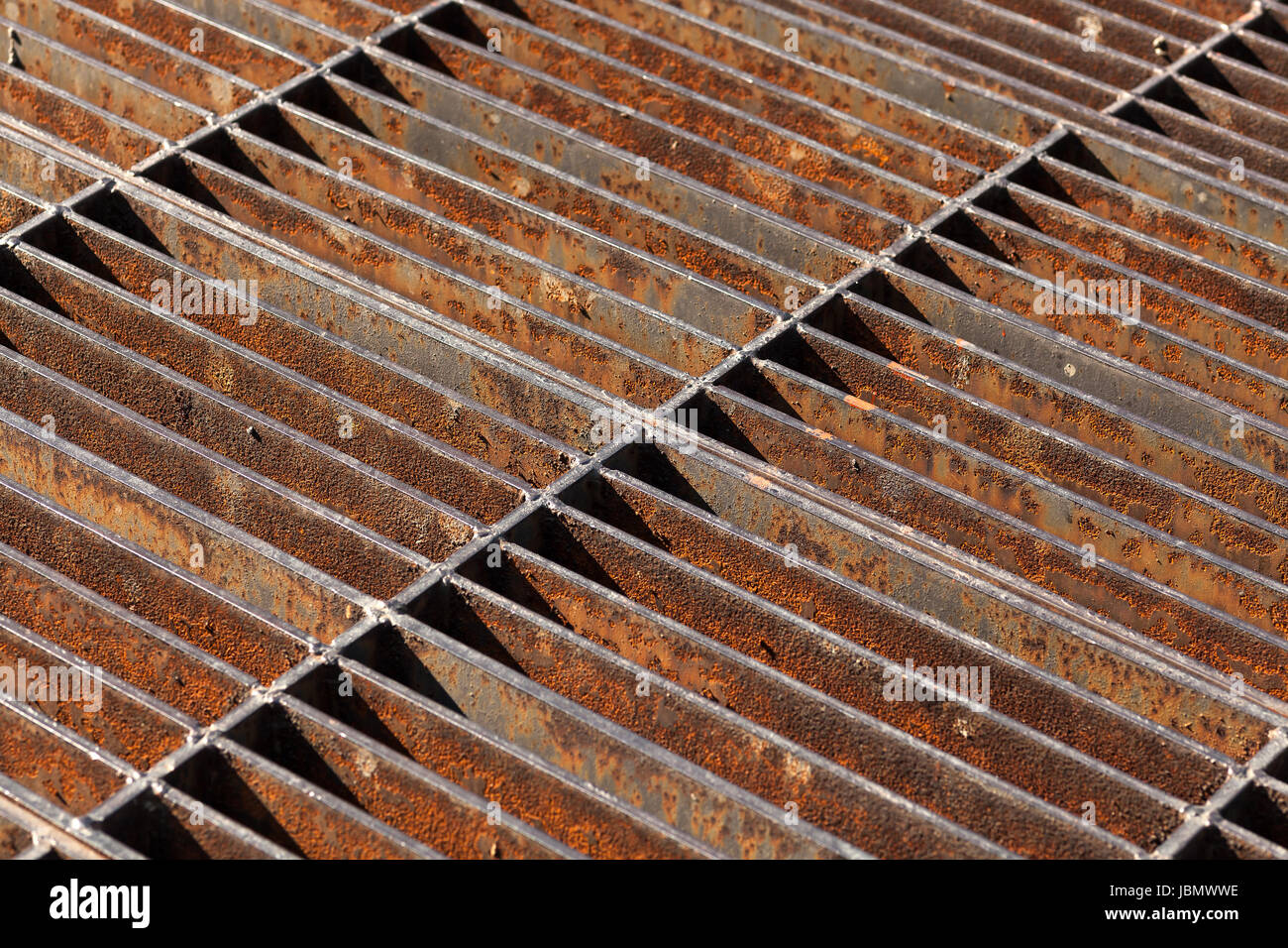 Rusty sewer grate on road Stock Photo - Alamy
