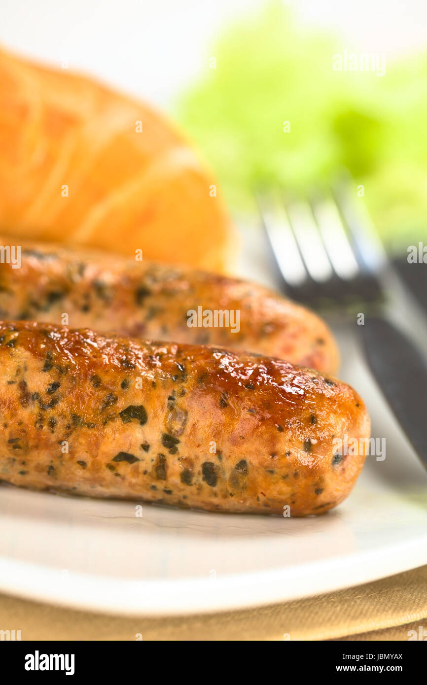 Fried bratwurst with bun, traditional German fast food served on plate ...