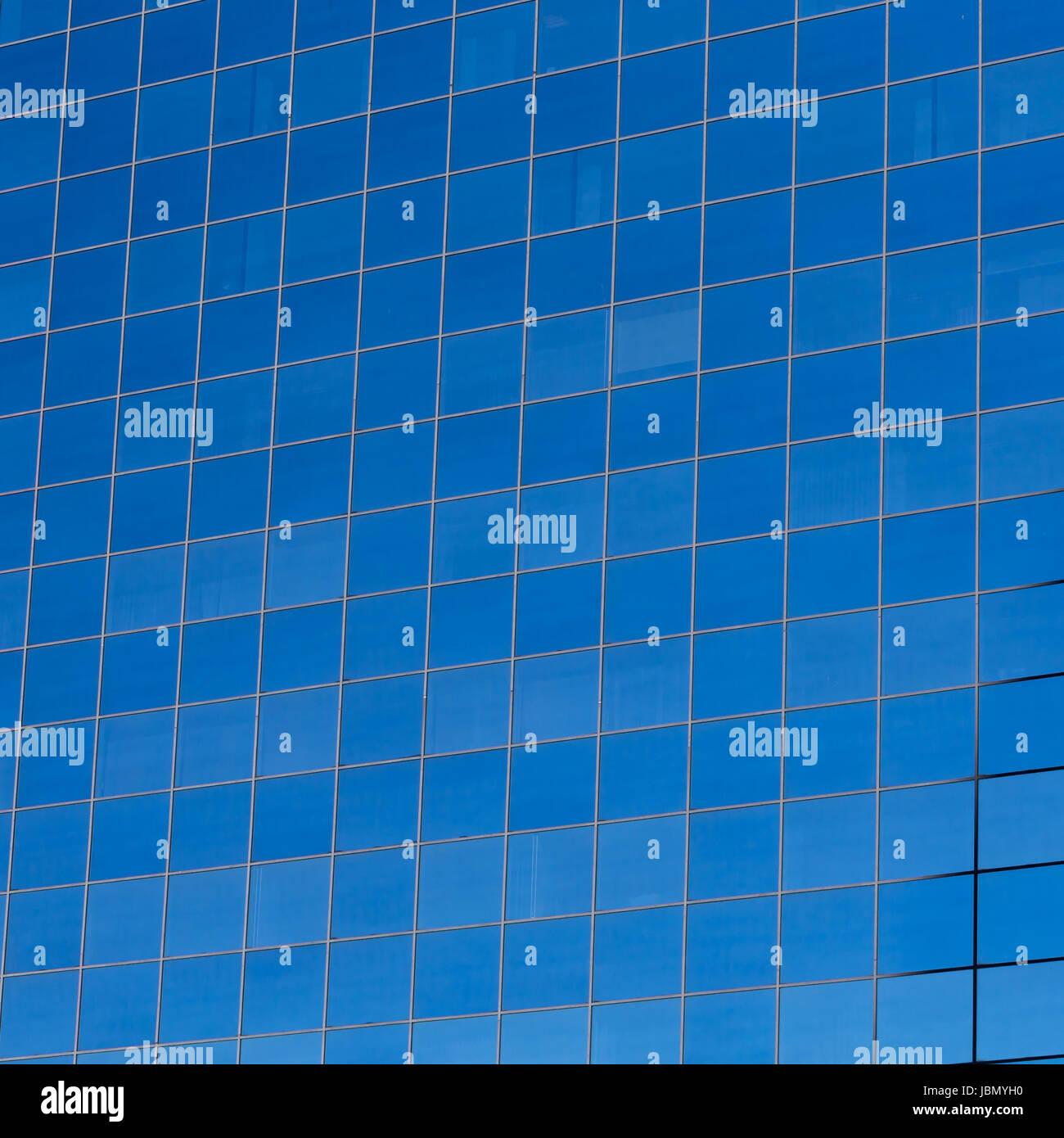 Glass building windows reflection on blue sky Stock Photo - Alamy