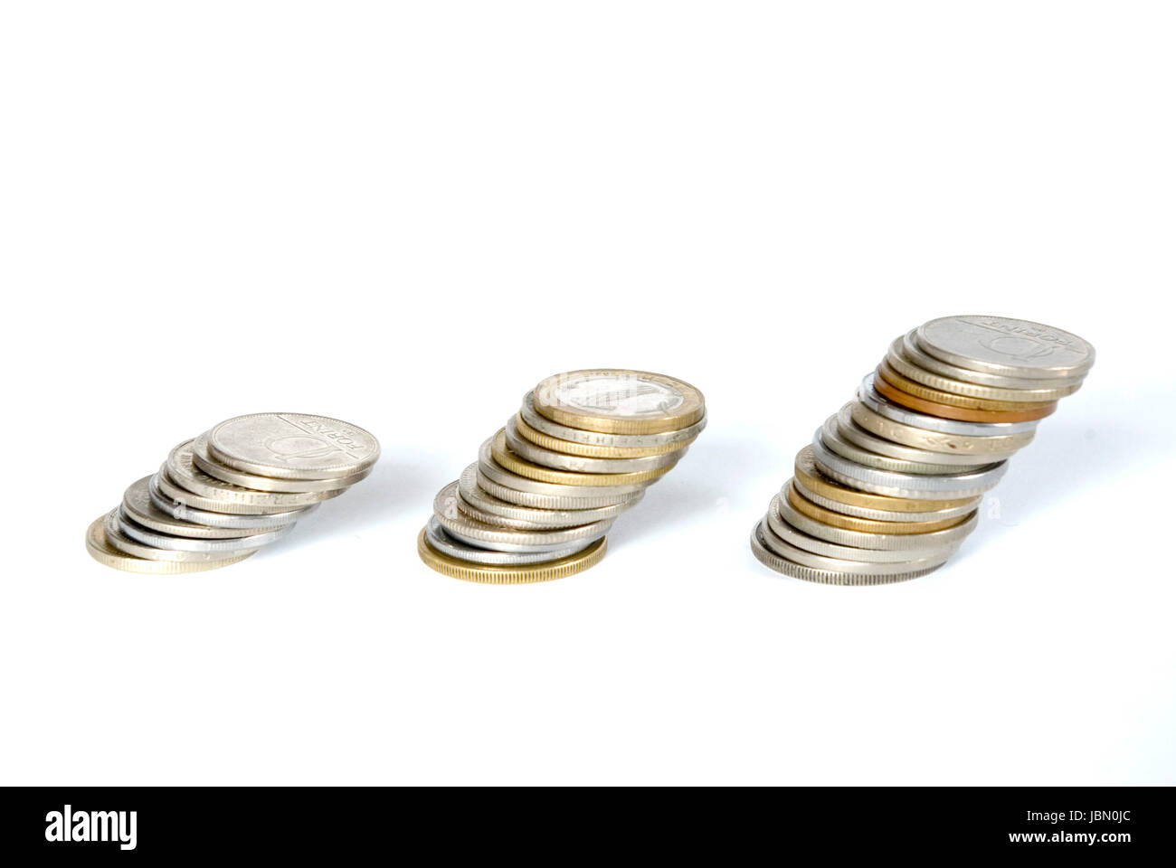 three towers of coins isolated on a whiteness Stock Photo - Alamy
