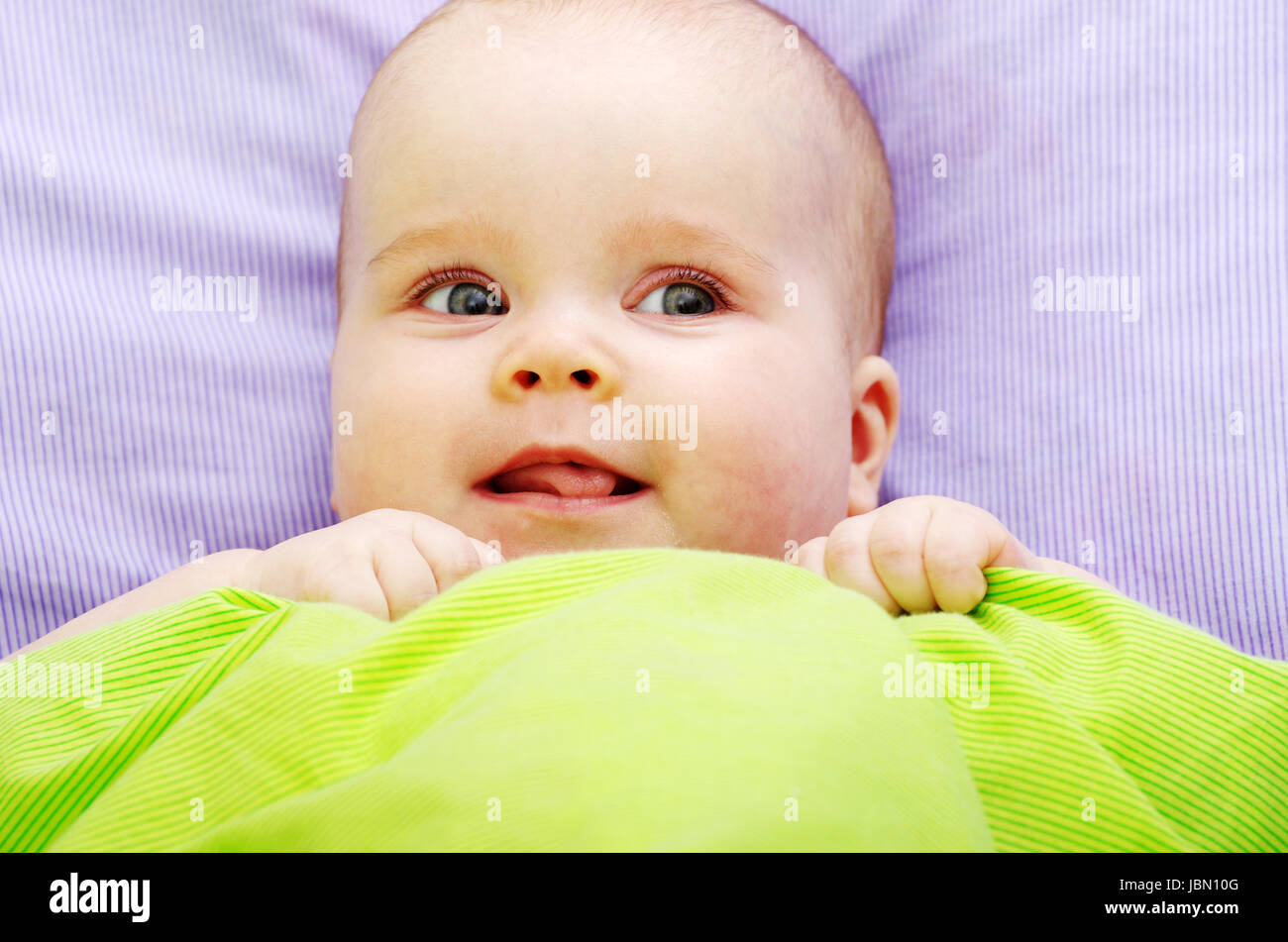 baby looking out from under blanket Stock Photo - Alamy