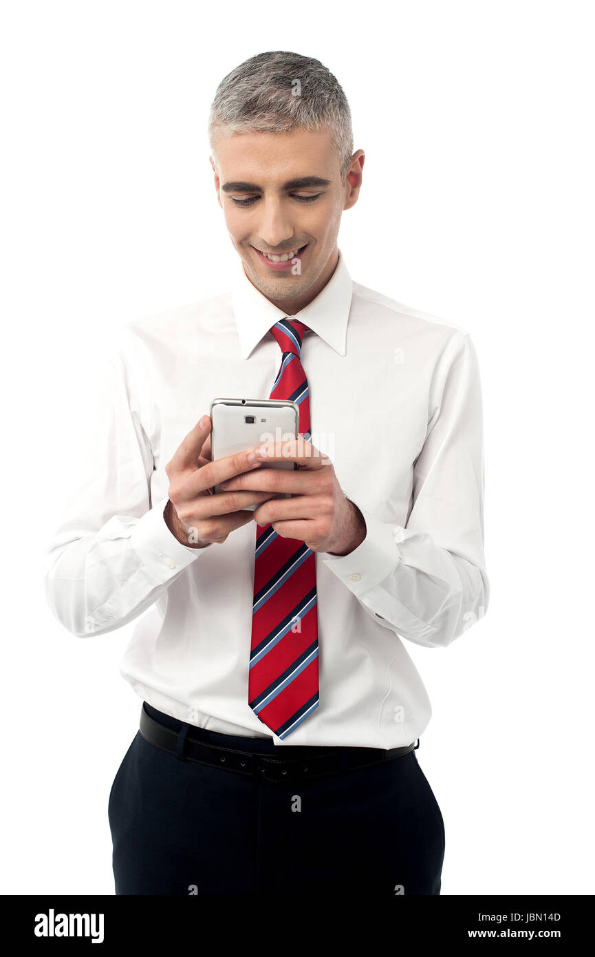 Handsome businessman text messaging on mobile phone Stock Photo - Alamy