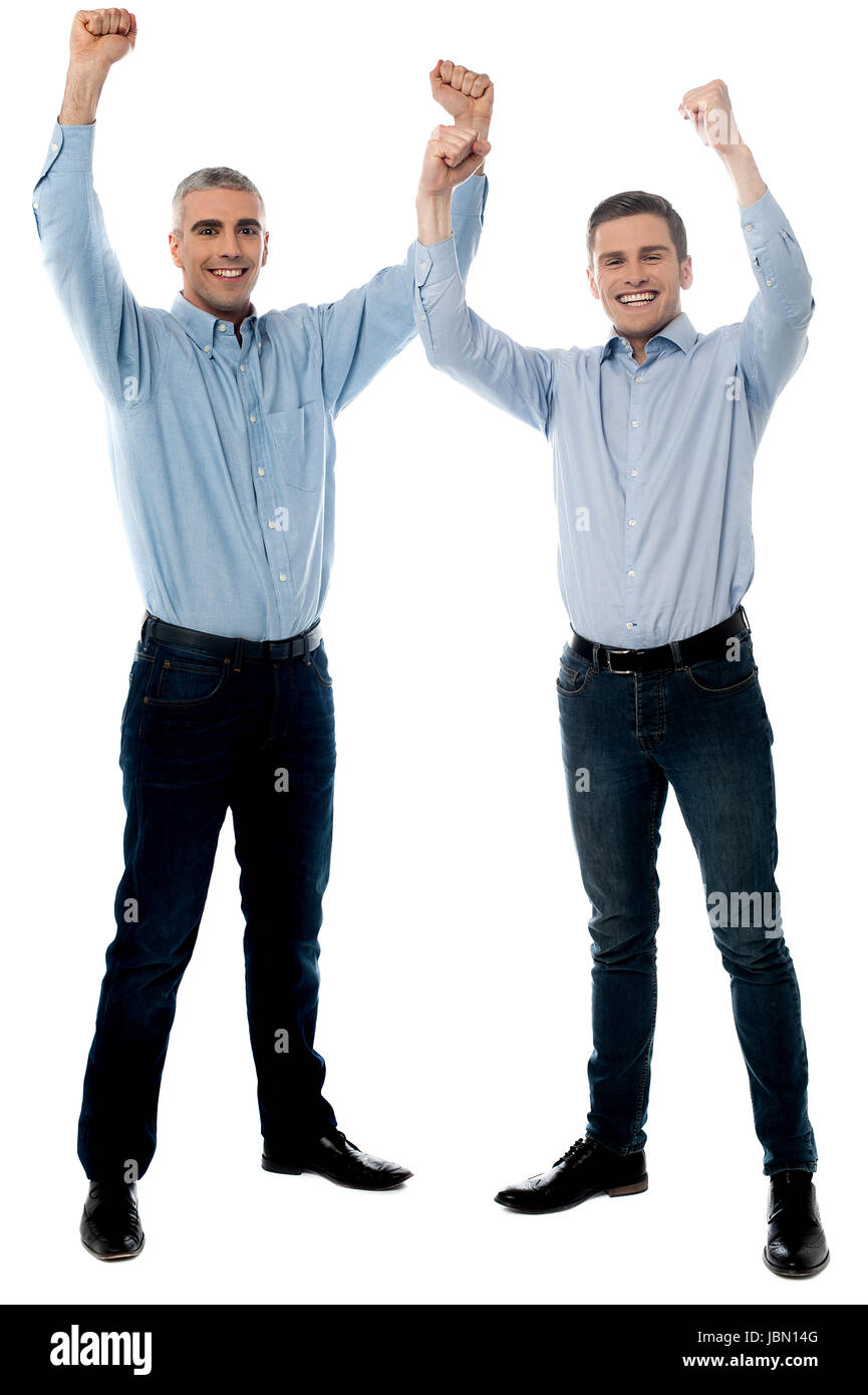 Successful handsome people celebrating with arms up Stock Photo - Alamy